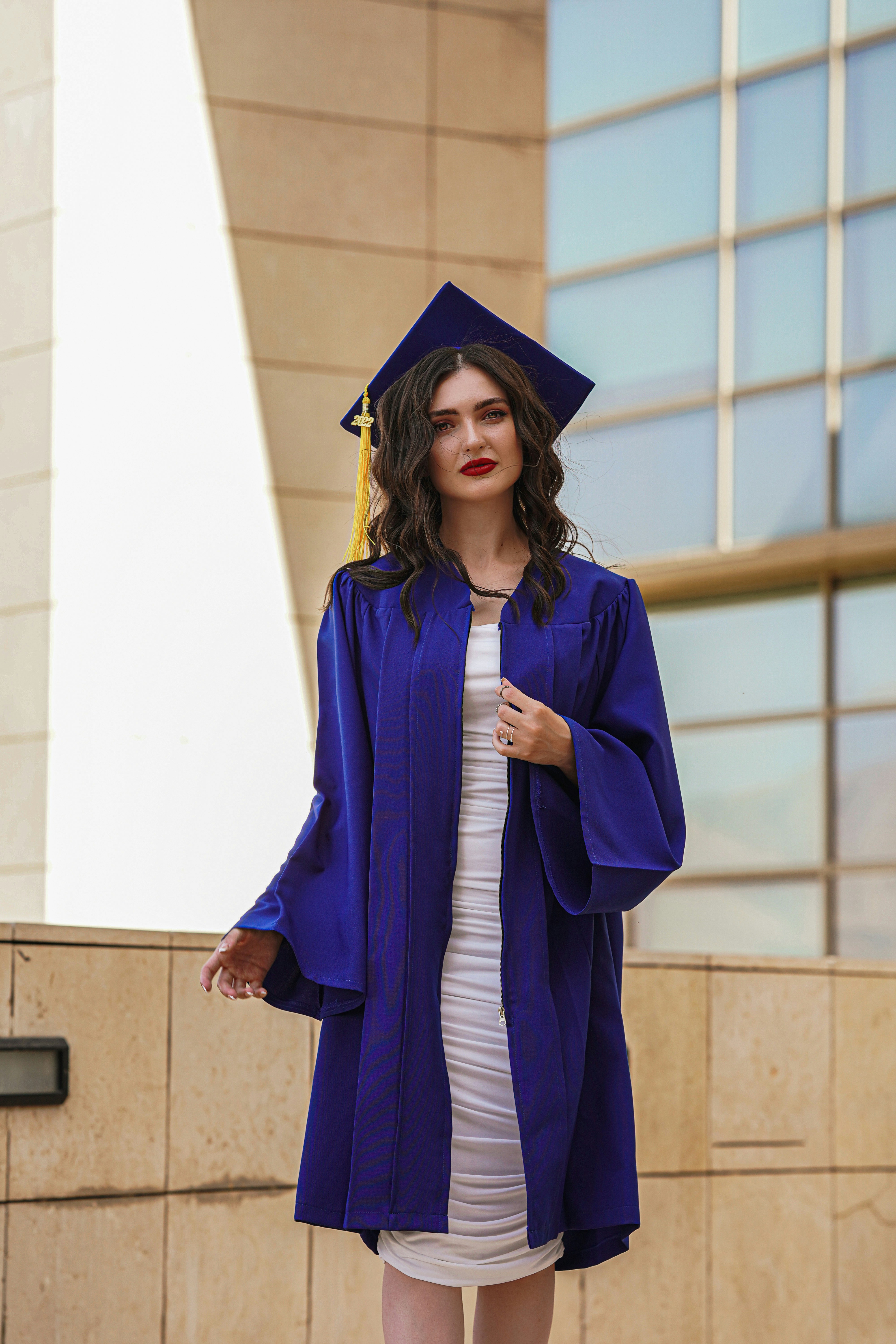 A woman in a graduation gown and cap photo – Free Student Image on Unsplash