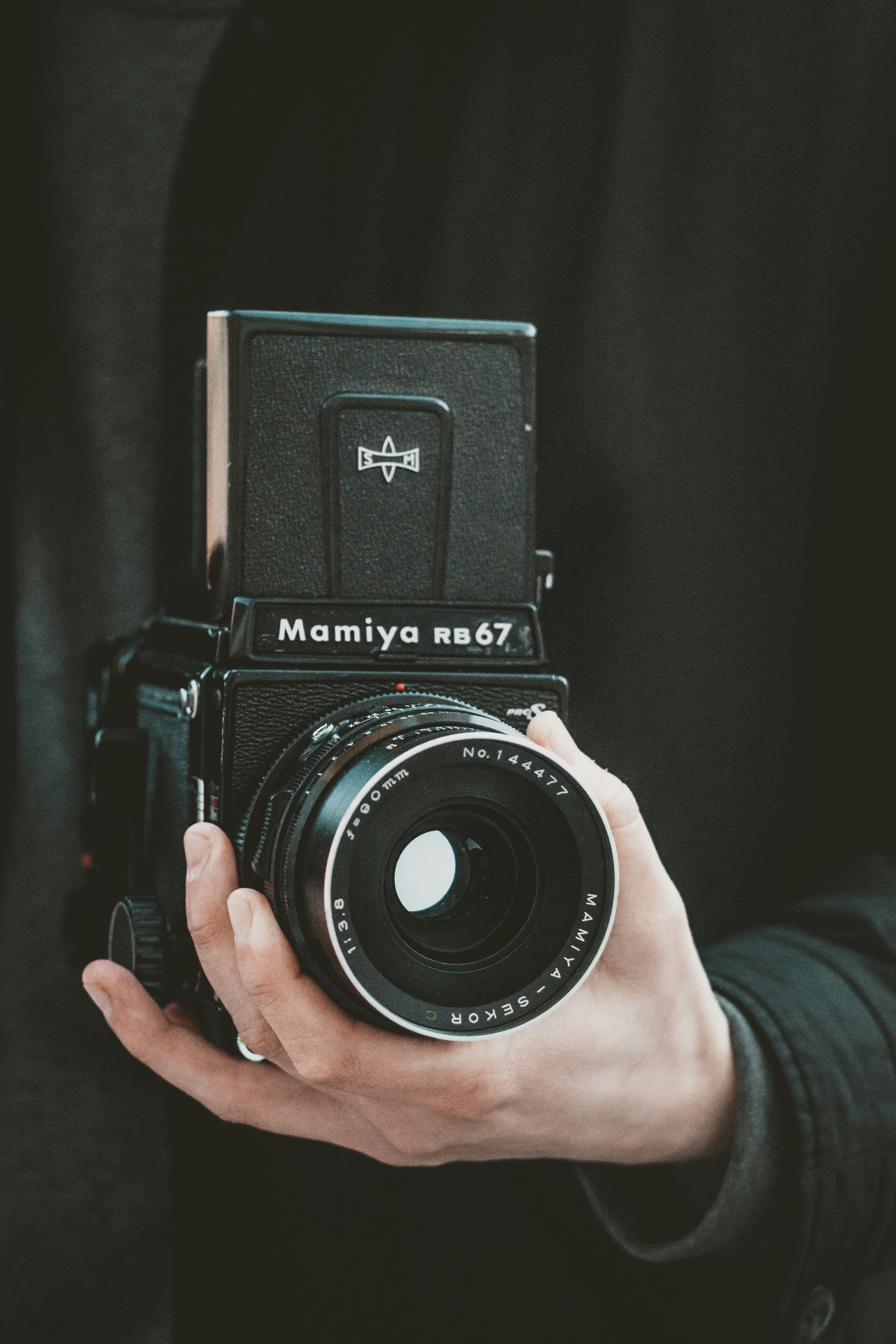 A person holding a camera in their hands photo – Free Business Image on ...