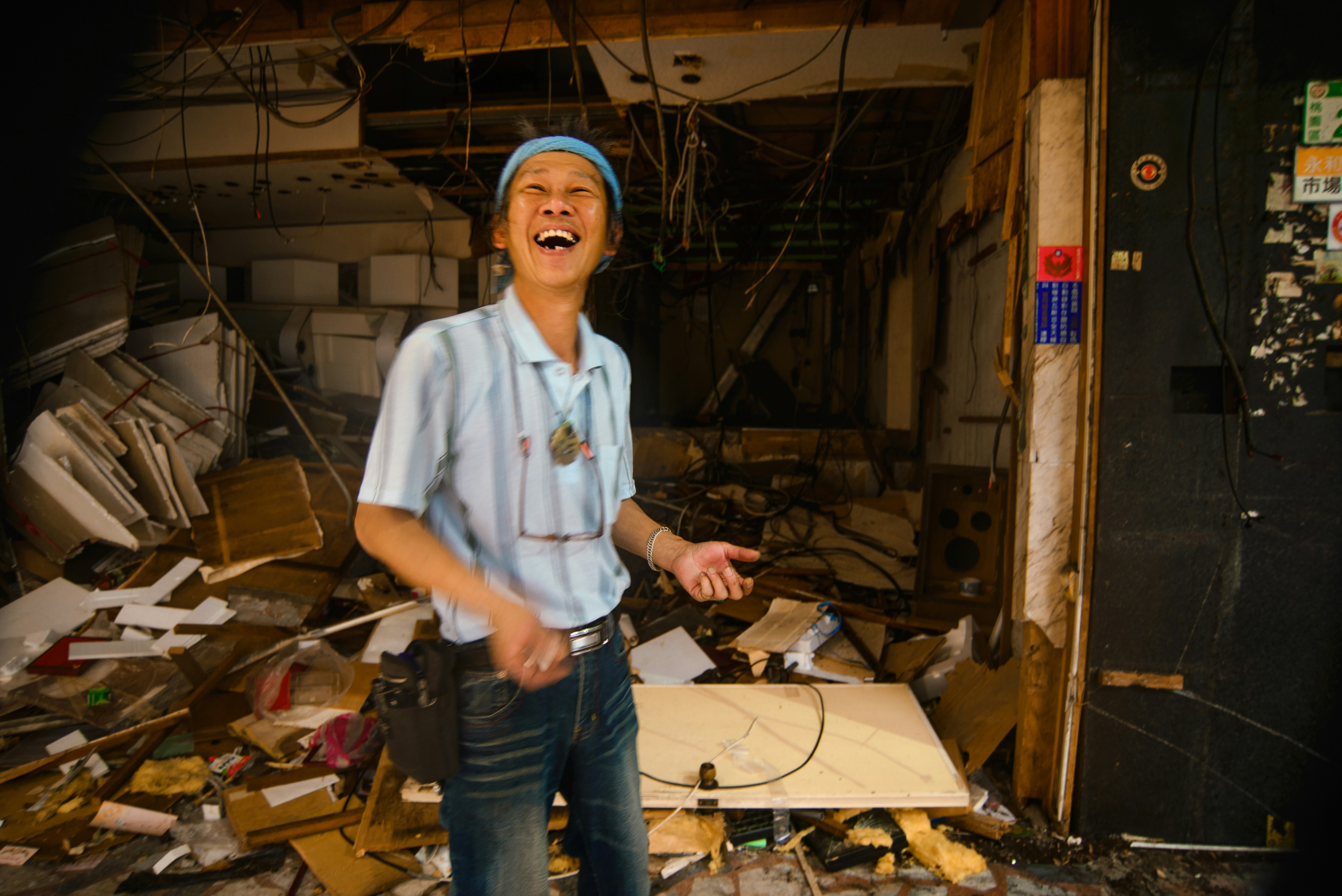 A young man standing in front of a pile of rubble photo – Free Head ...