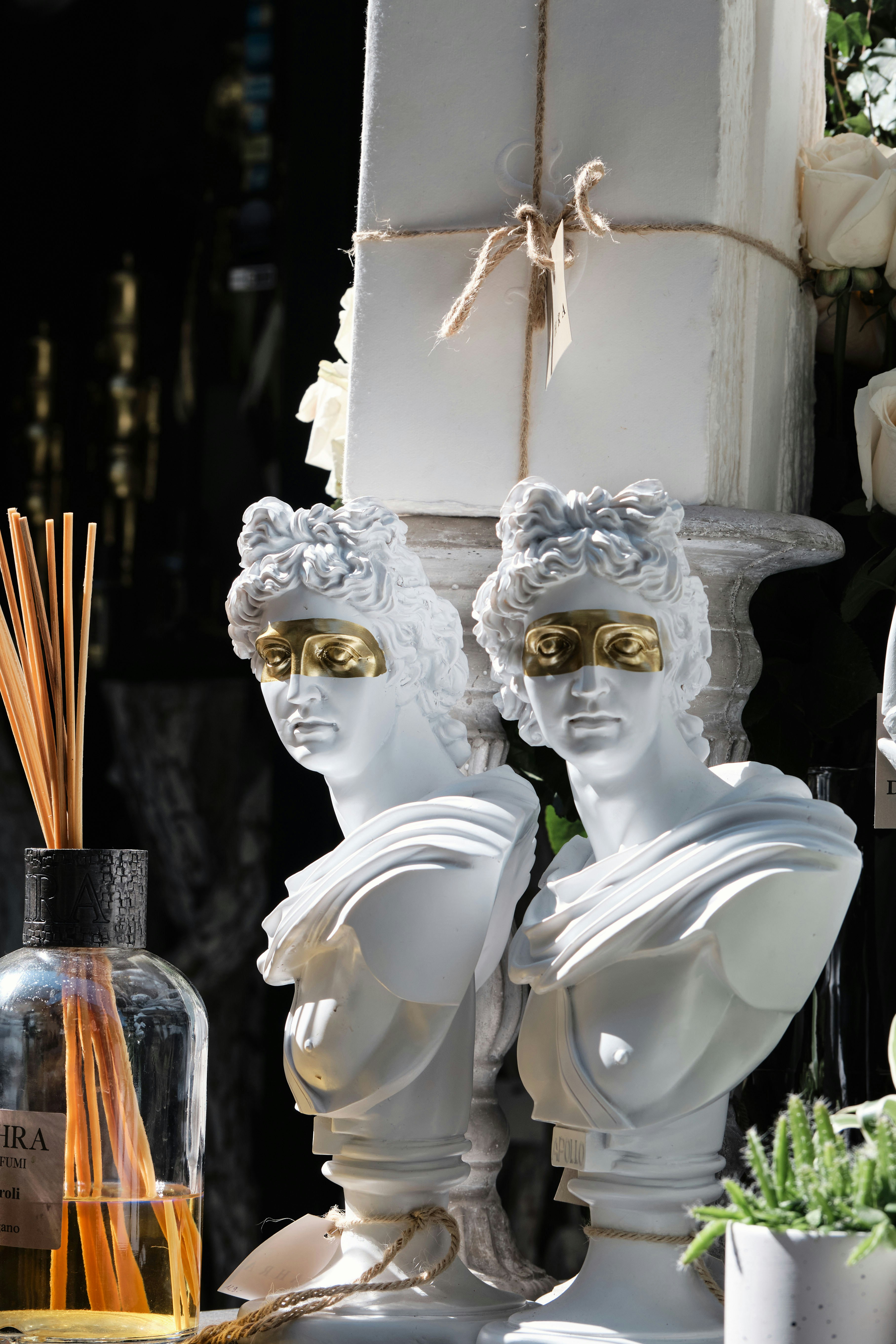 Statues with Golden Veil: Classical Cherubs Guarding a Fragrant Alcove