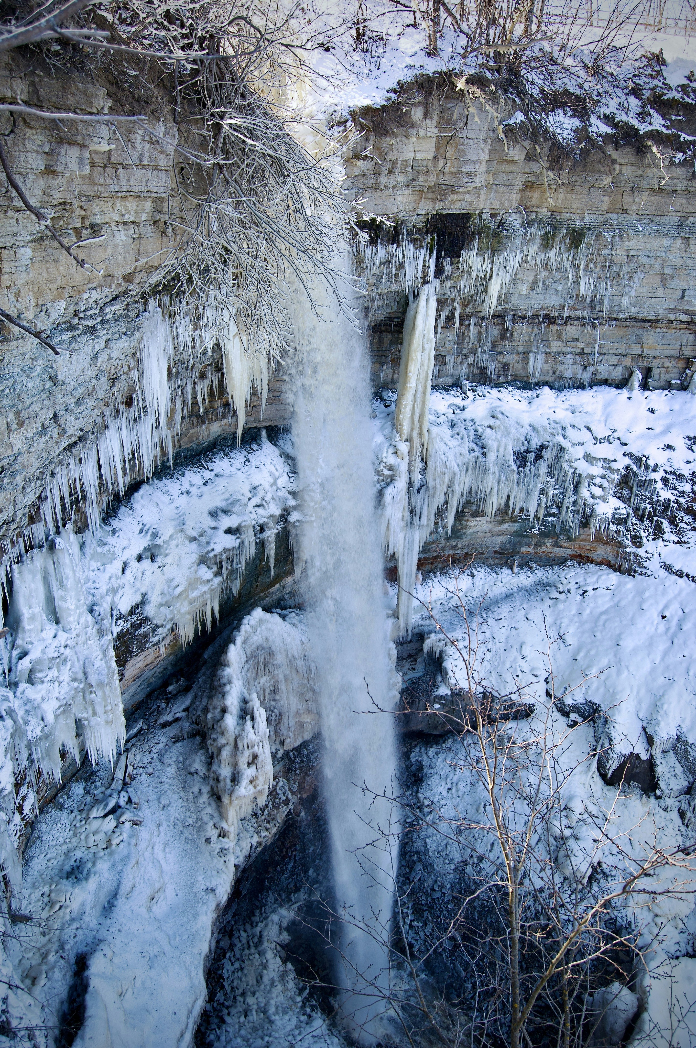 a large waterfall with icicles on the side of it