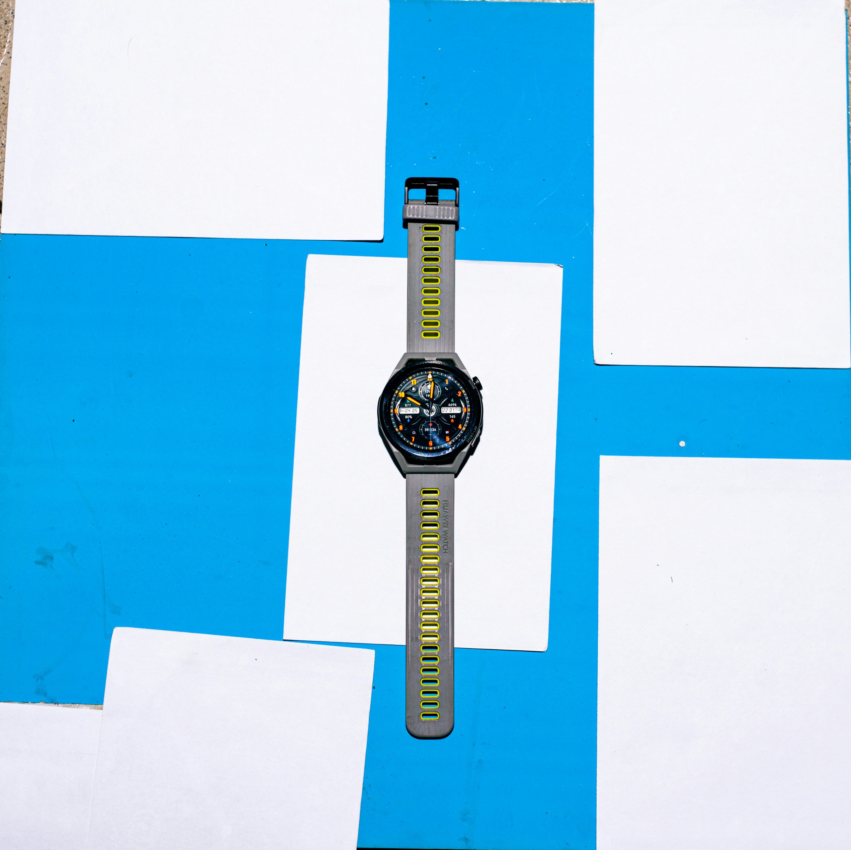 a watch sitting on top of a blue and white floor
