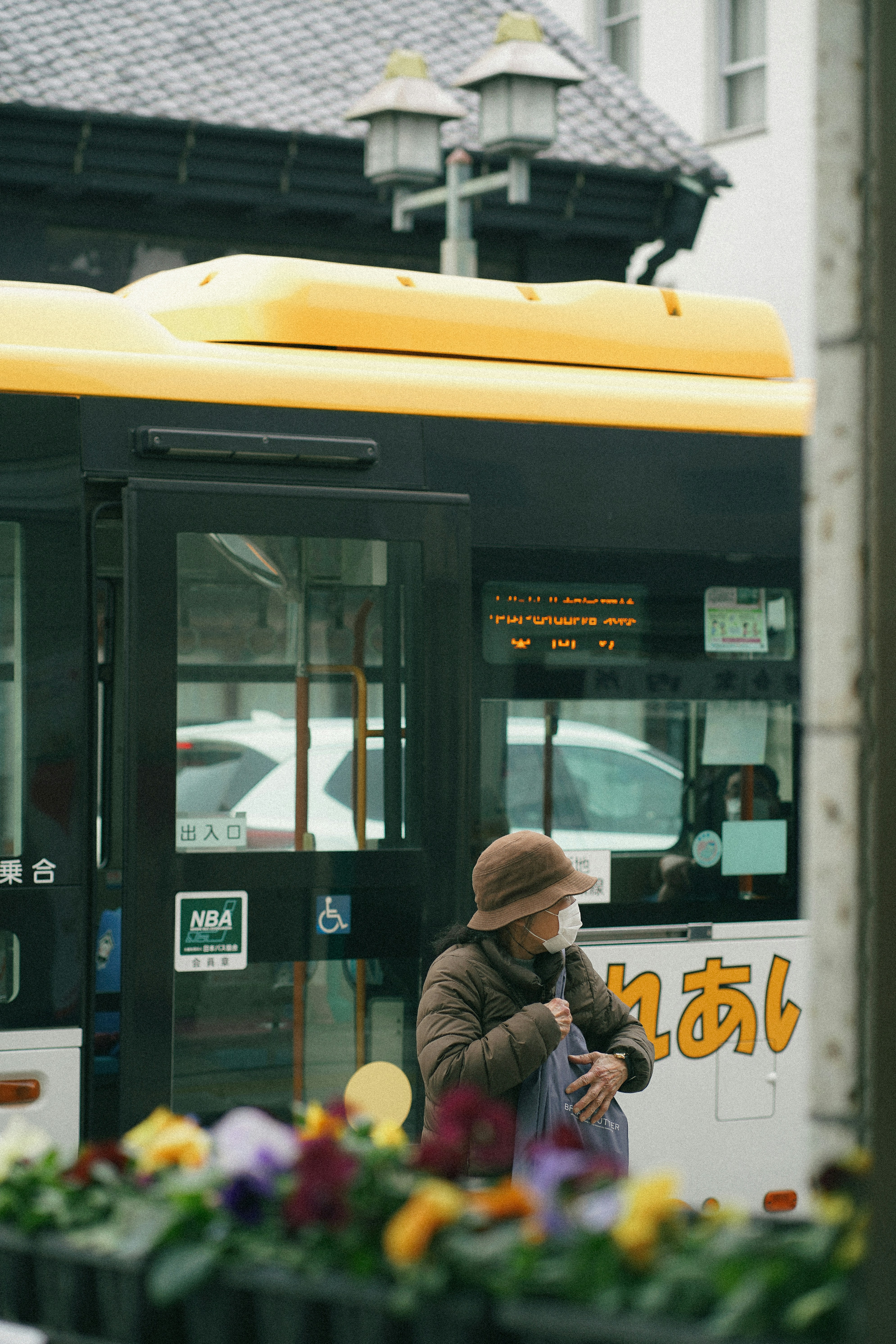 A lady getting off a bus in Japan