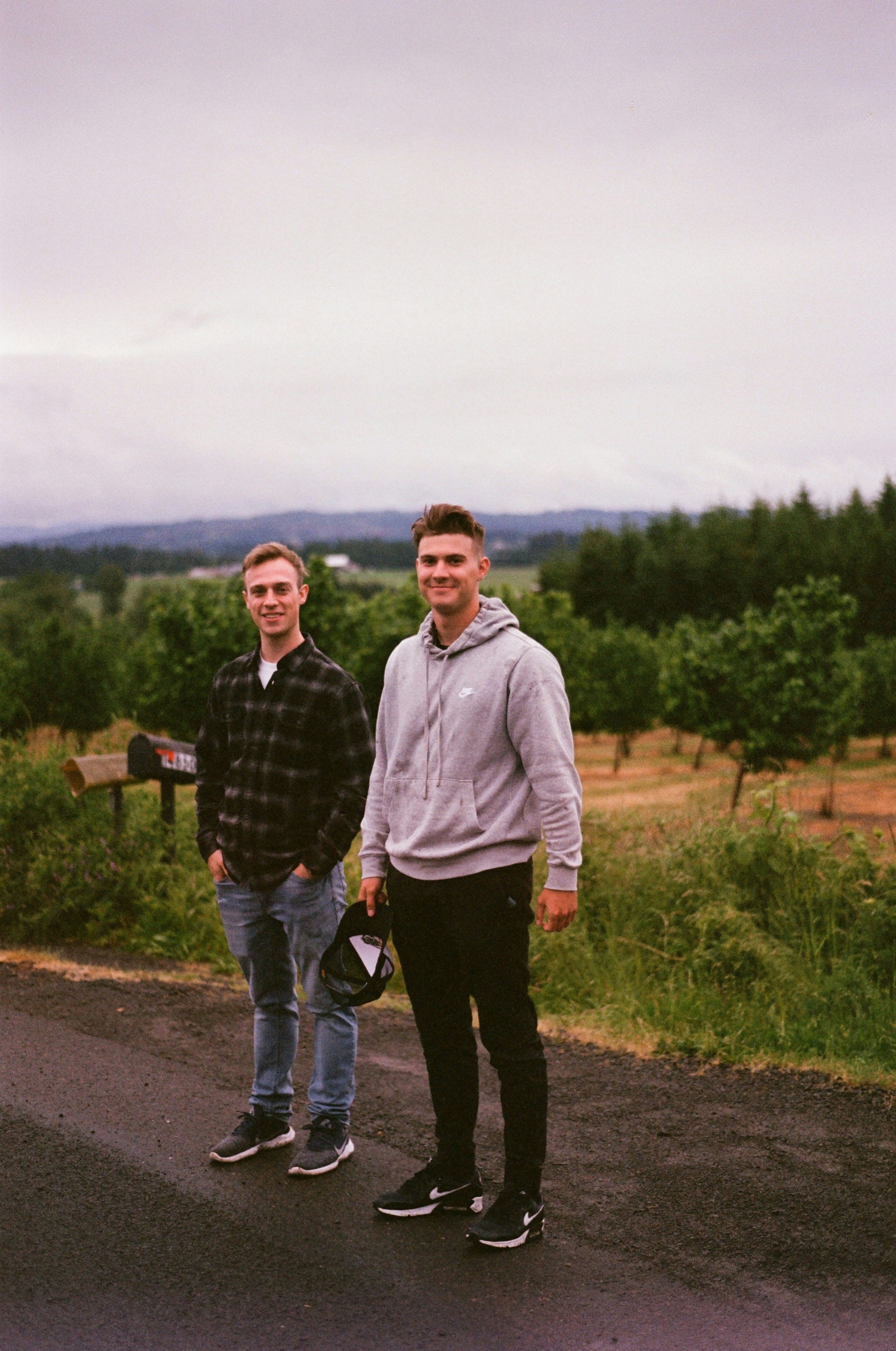 Two men standing on the side of a road photo – Free Land Image on Unsplash