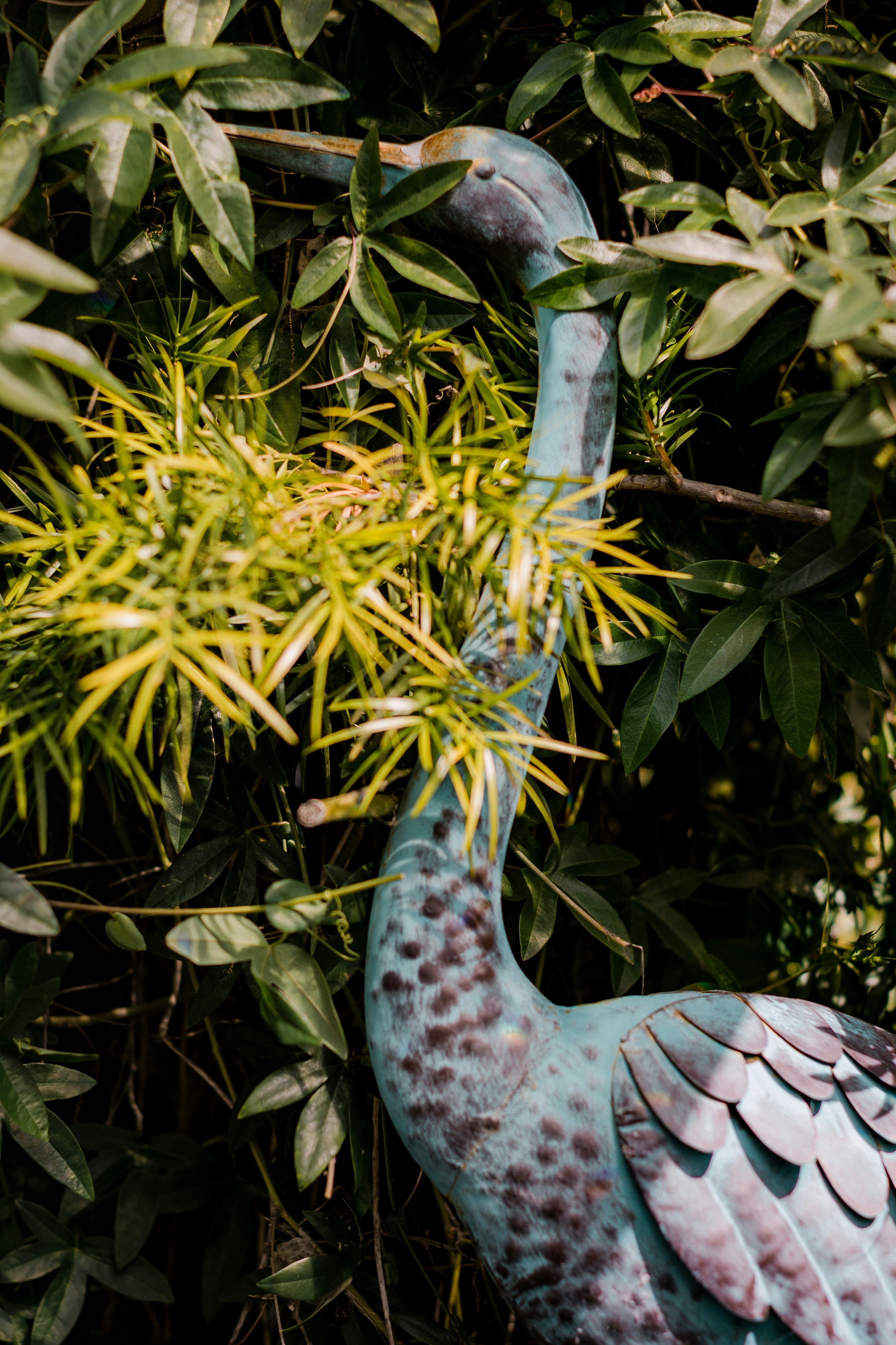 a statue of a bird with a long neck and wings