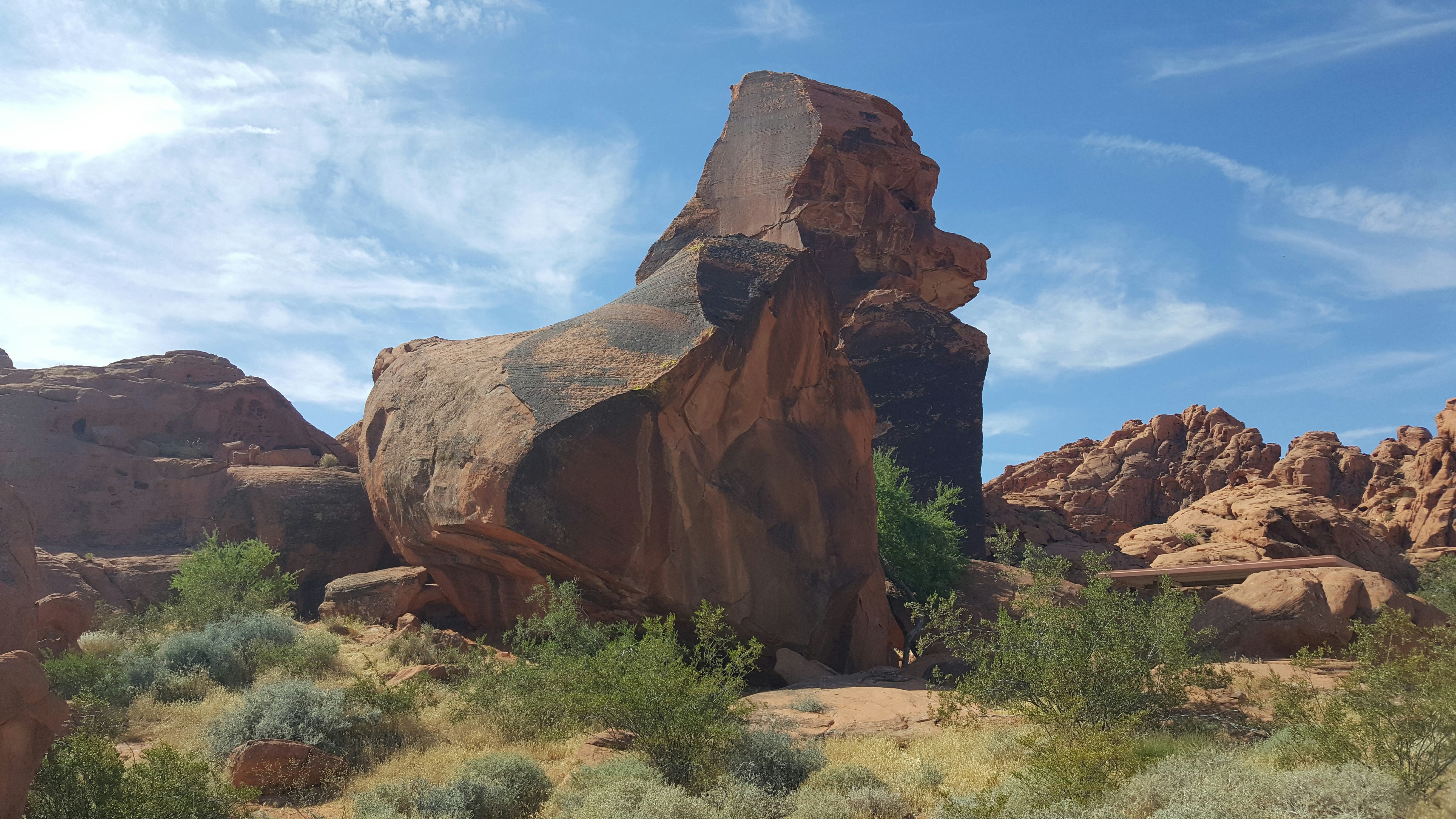 Stone Sentinel: A Weathered Monolith Rising Over Desert Scrub
