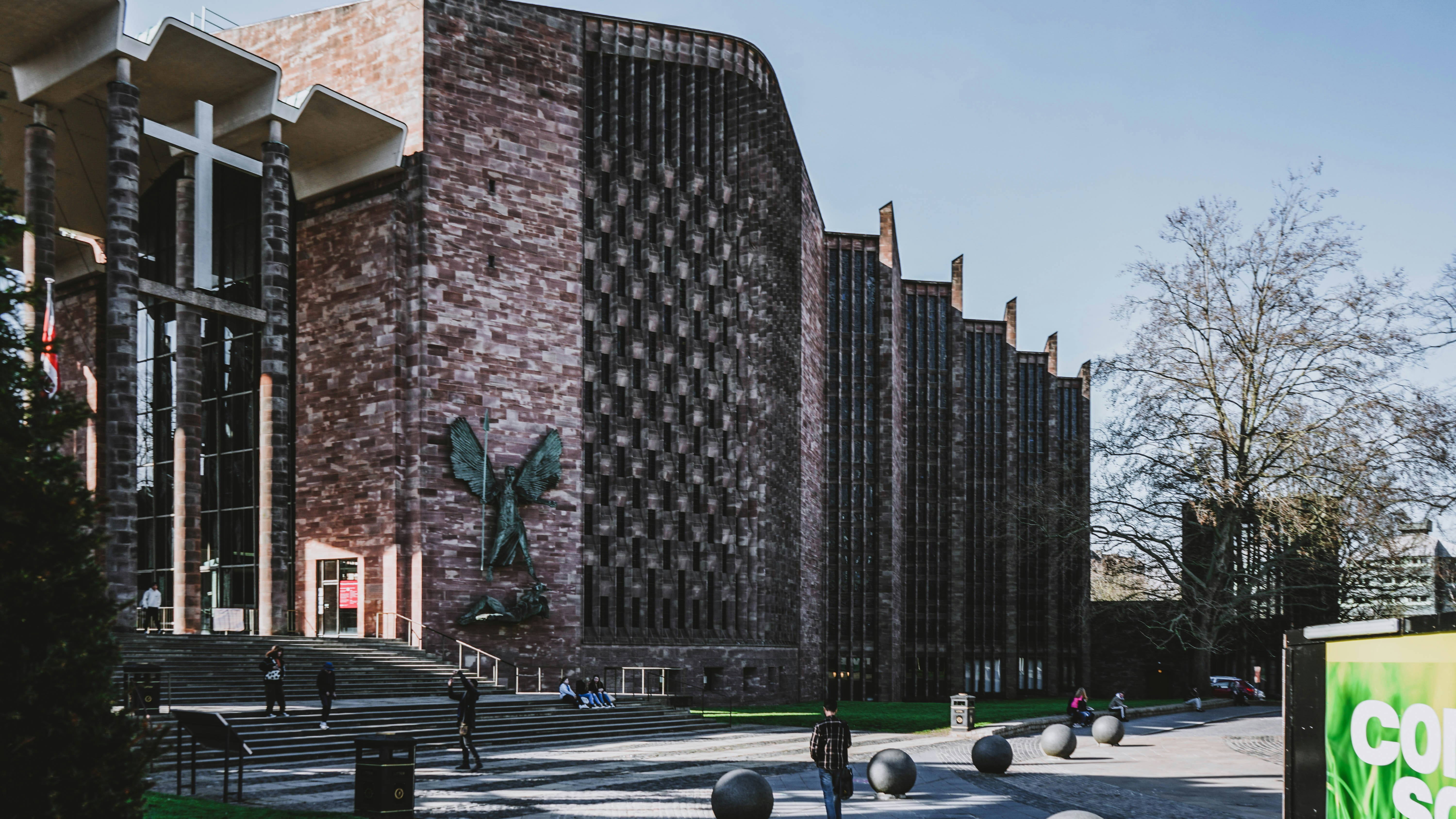 Modernist serenity | a brick building with a green sign in front of it