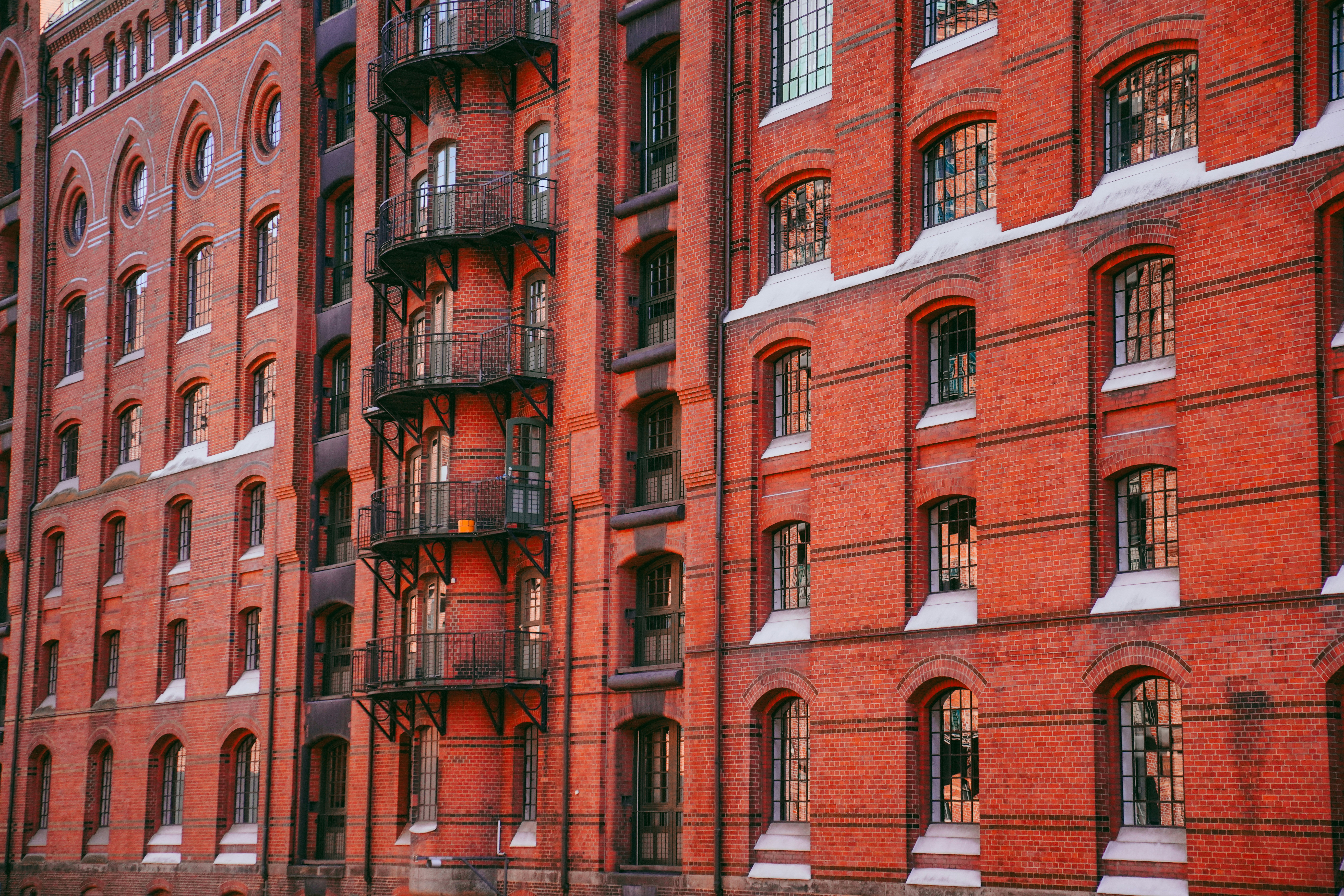 A row of red brick buildings with balconies photo – Free Hamburg Image ...