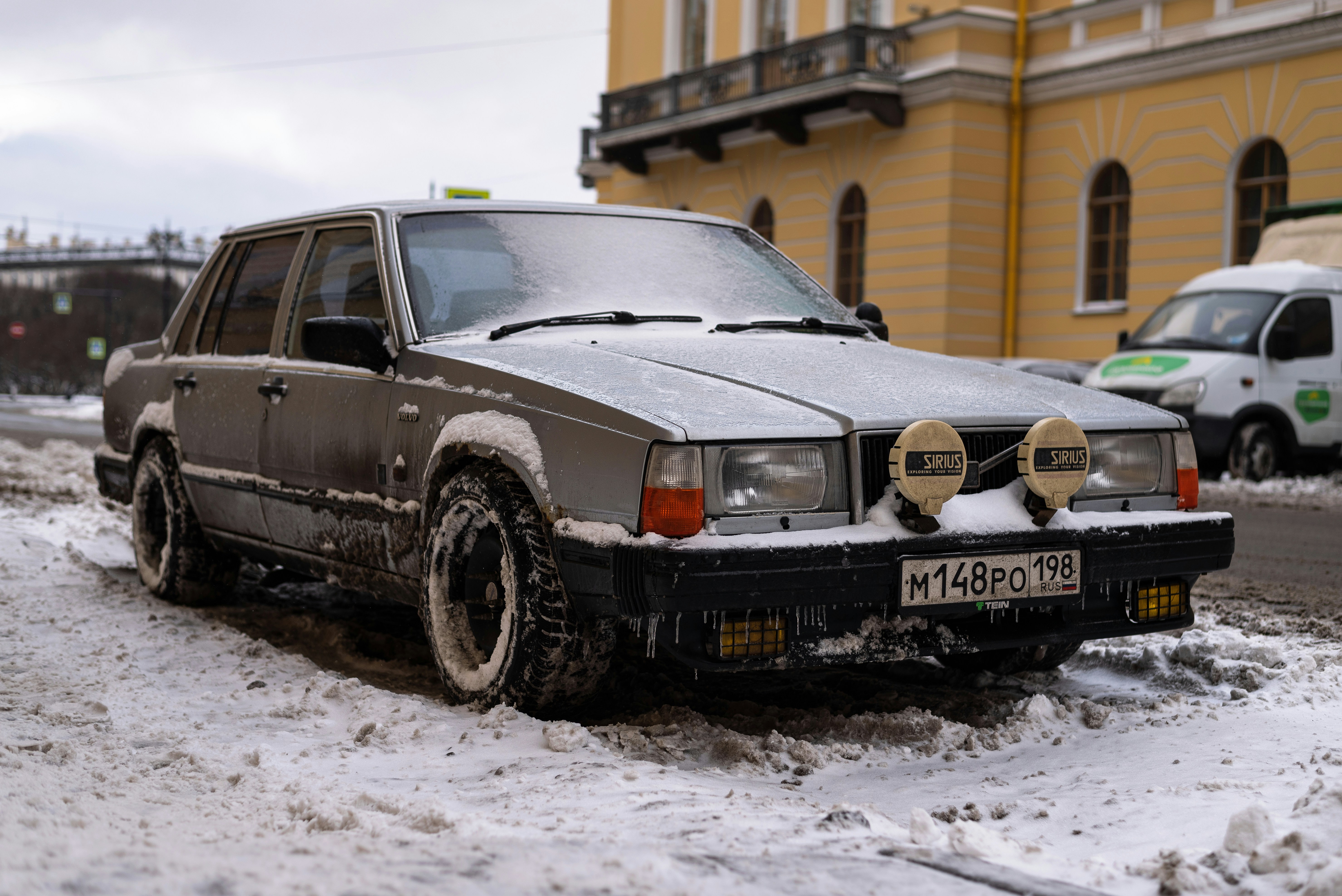 Snowbound Sedan with Twin Rally Lamps: A Quiet Winter Street Scene
