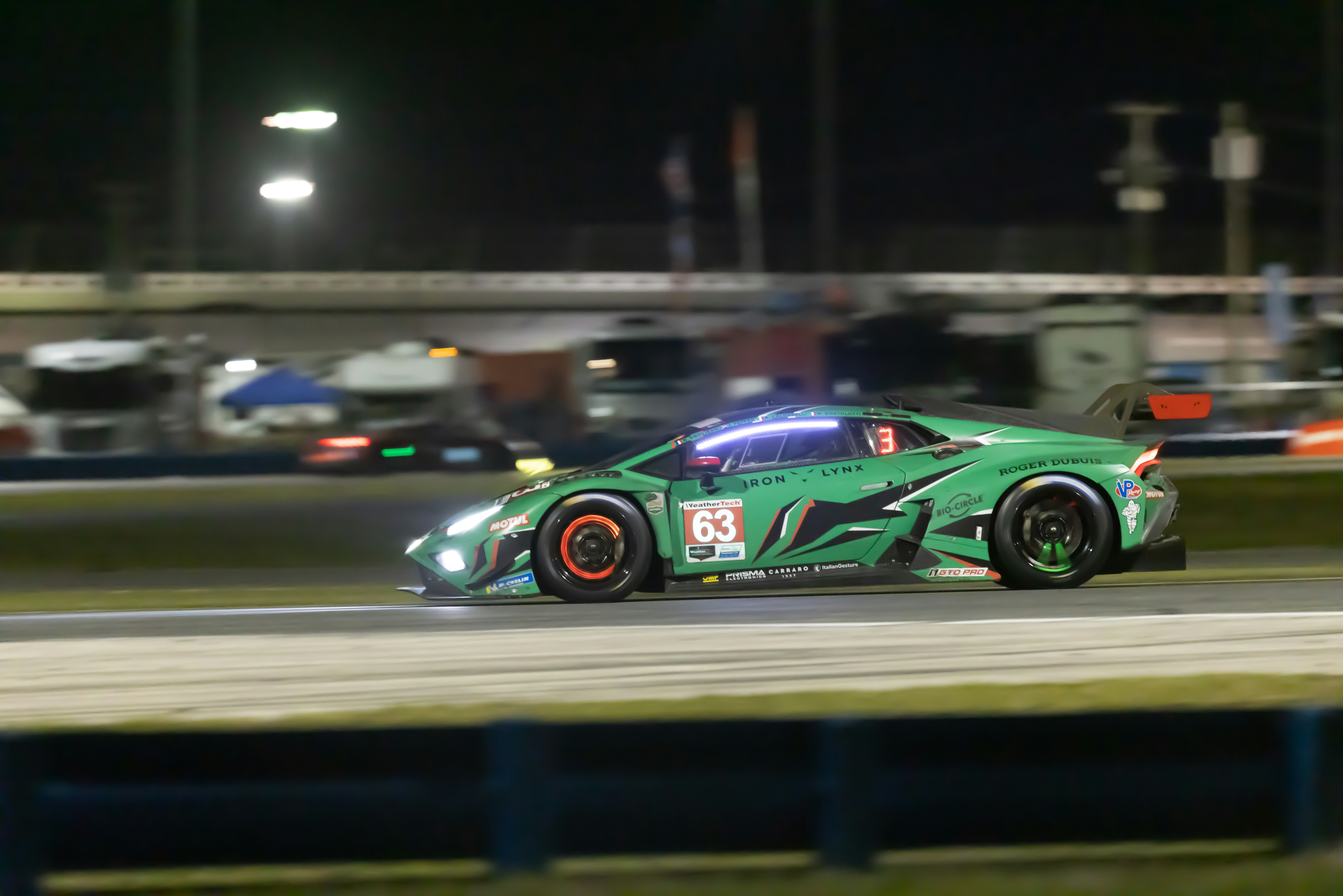 A green sports car driving on a race track photo – Free Vehicle Image ...