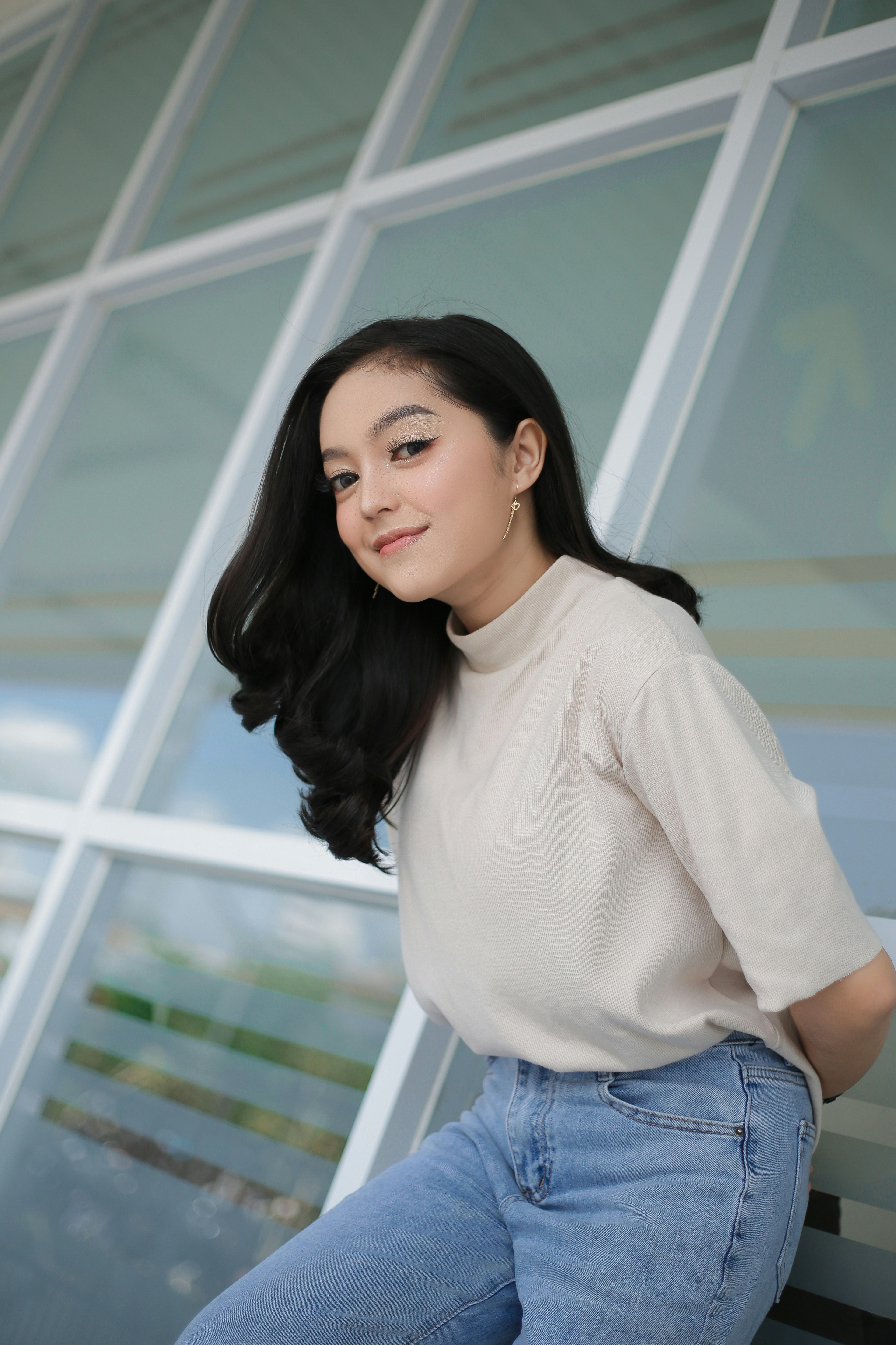 A woman posing for a picture in front of a window photo – Free Garut ...