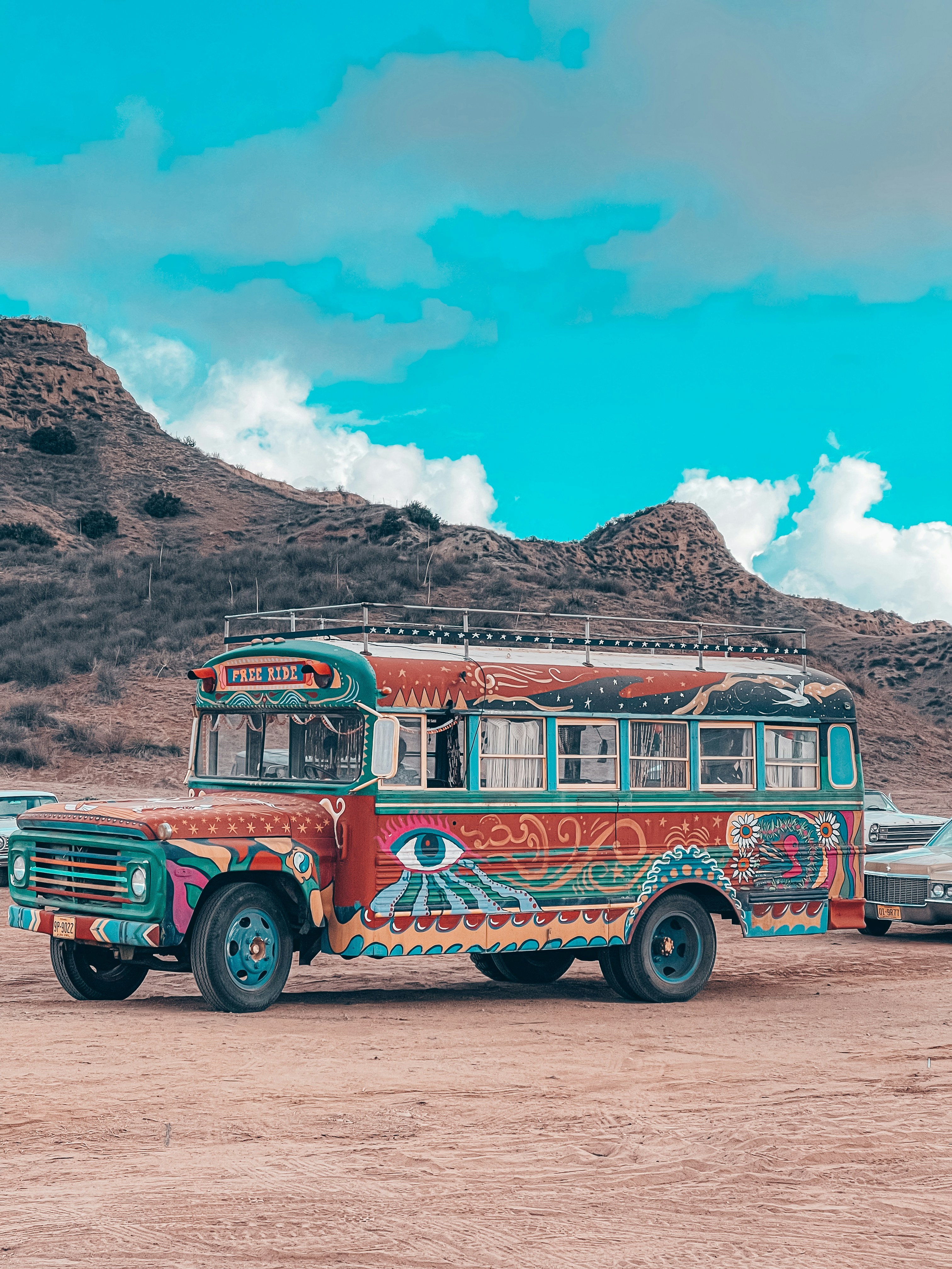 A colorful bus parked on a dirt road photo – Free Bus Image on Unsplash