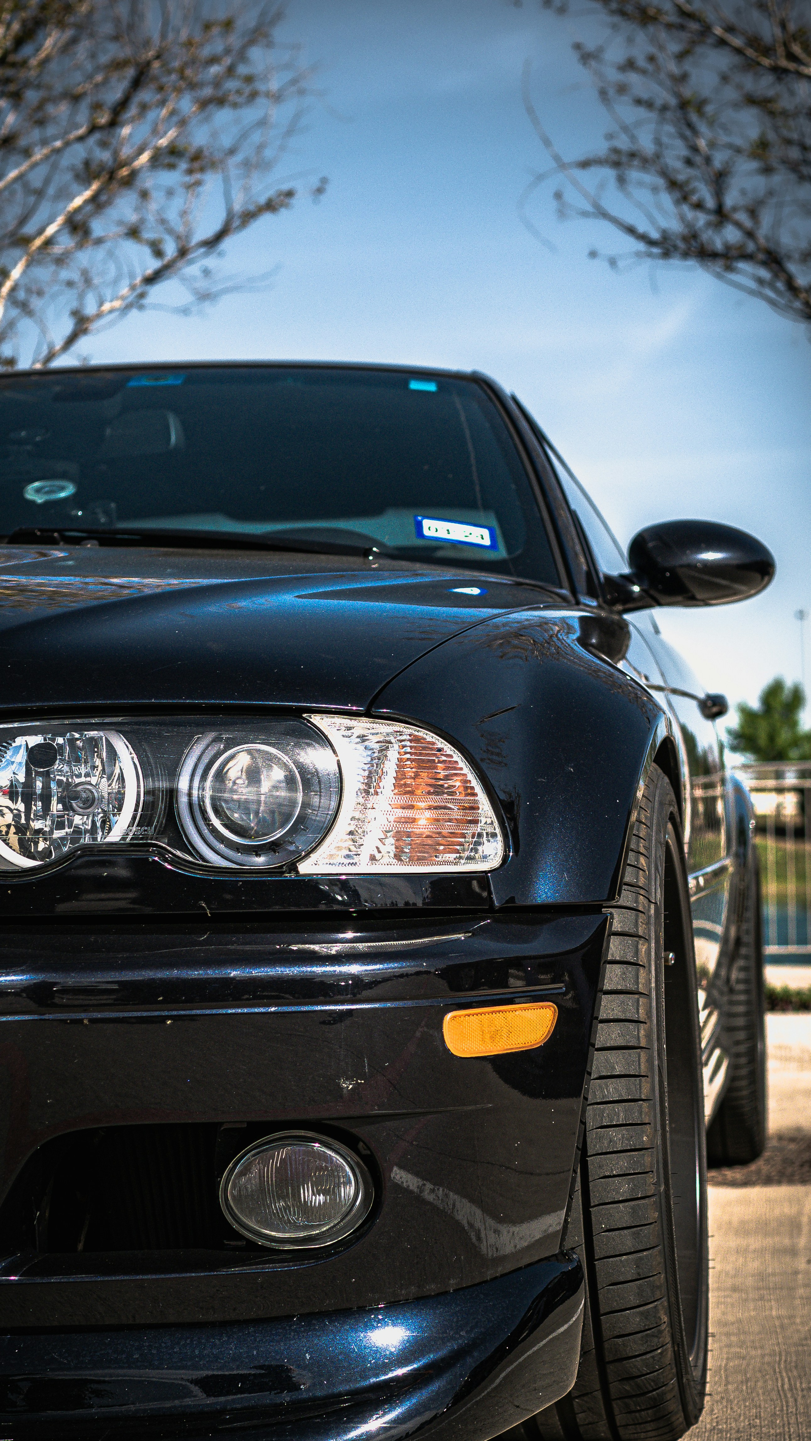 Low-Angle Front Quarter Focus: A Black Sedan in Crisp Daylight