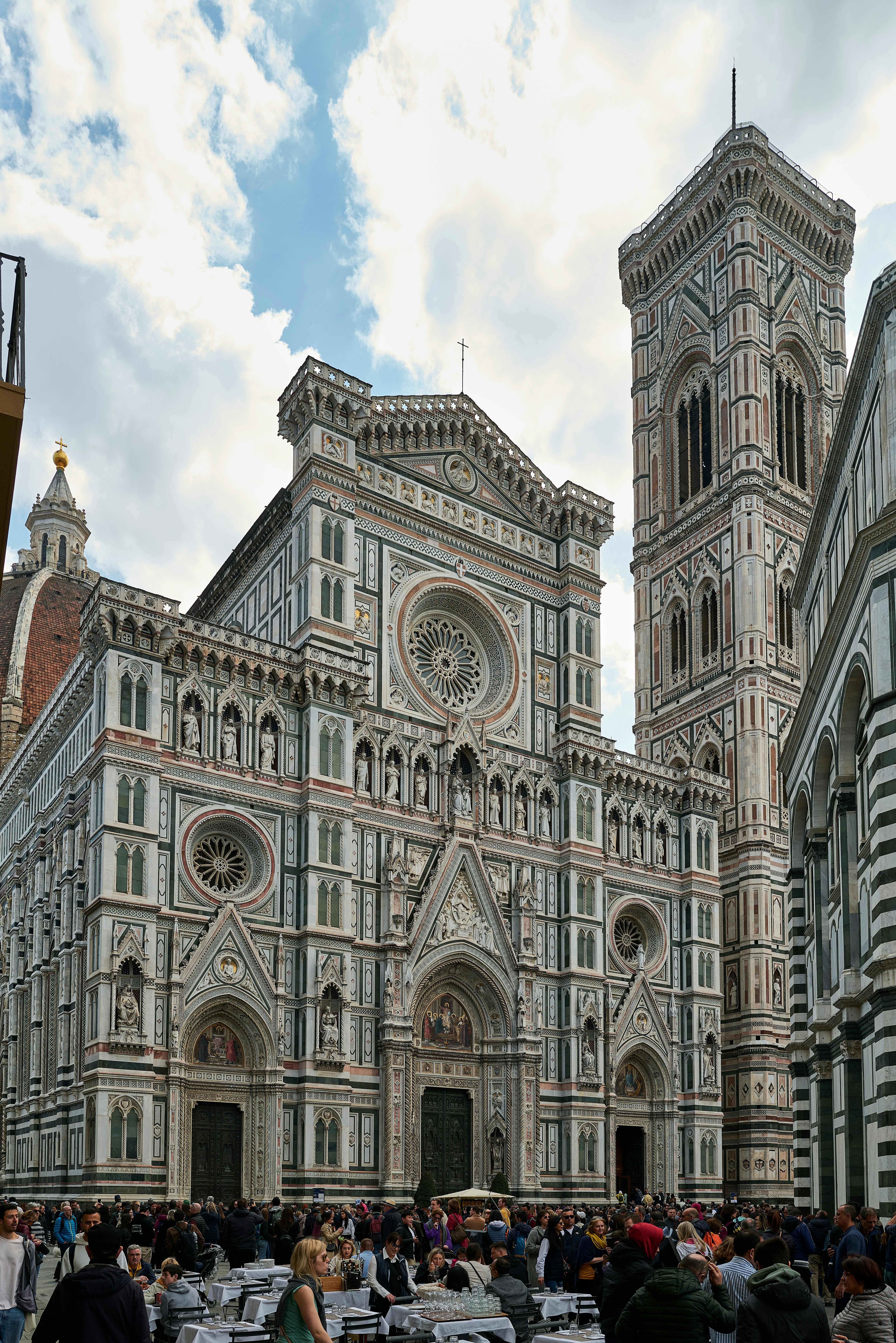 a group of people standing in front of a large building