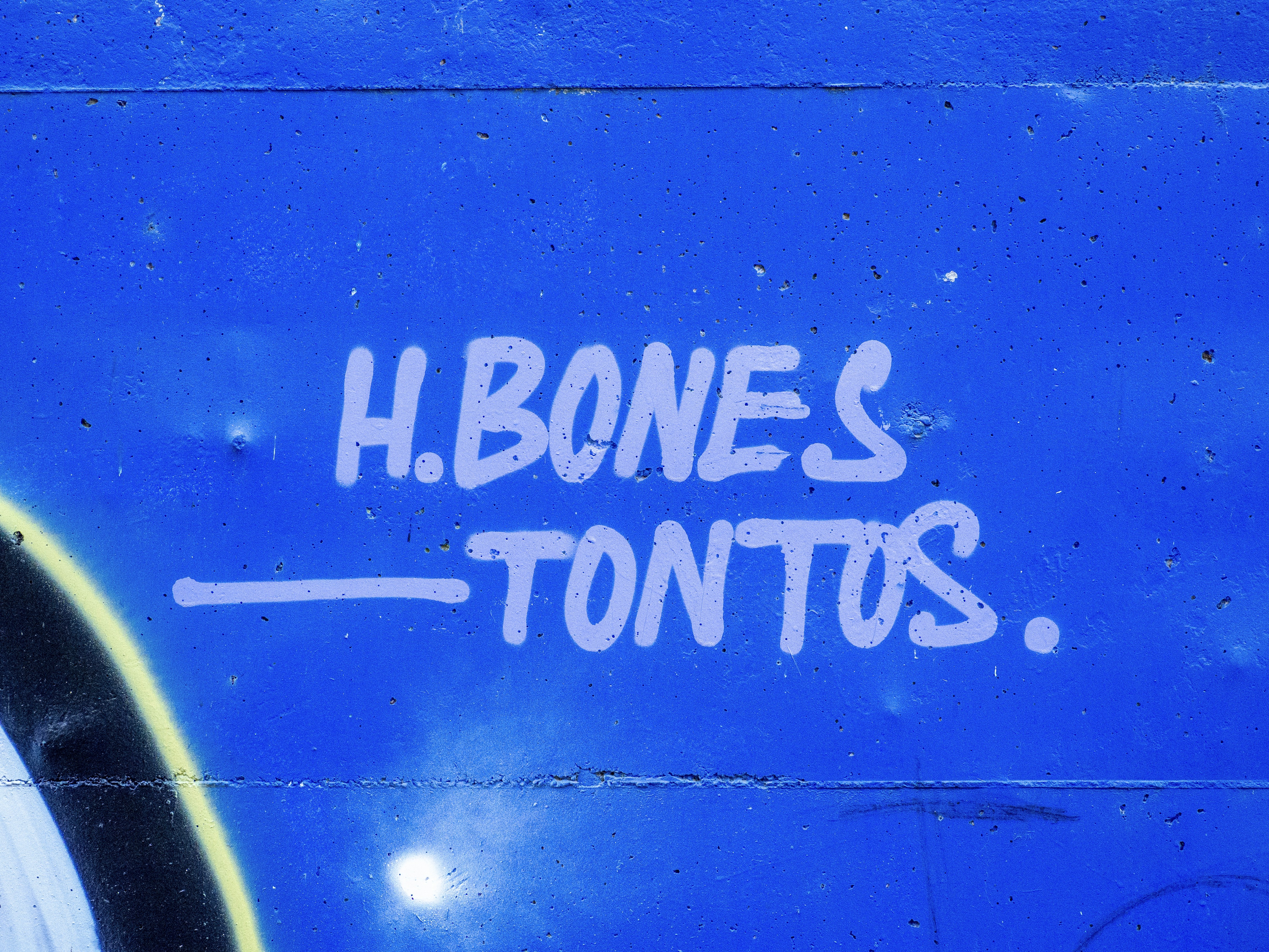 Graffiti on the side of a blue wall that says h bones tons photo – Free ...