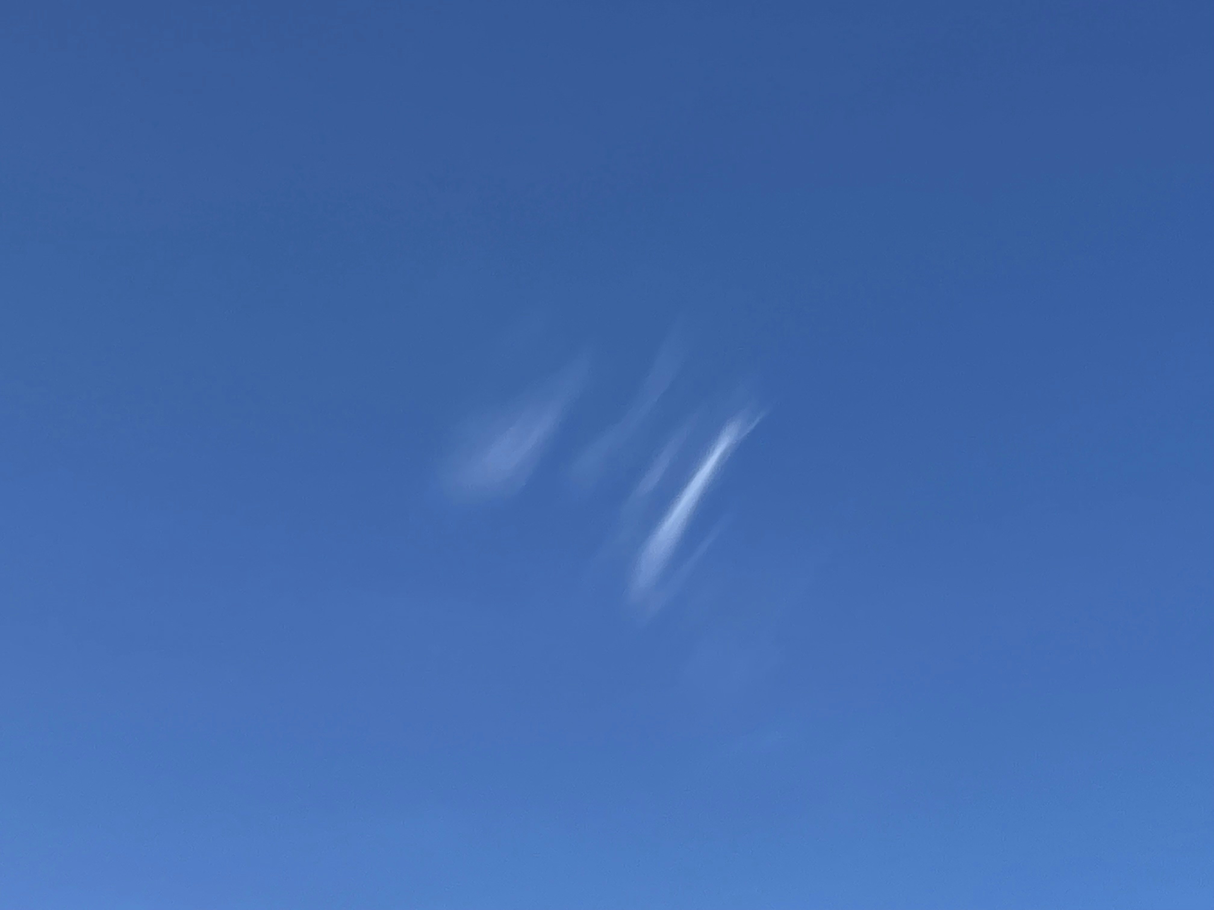 a clear blue sky with some clouds in it