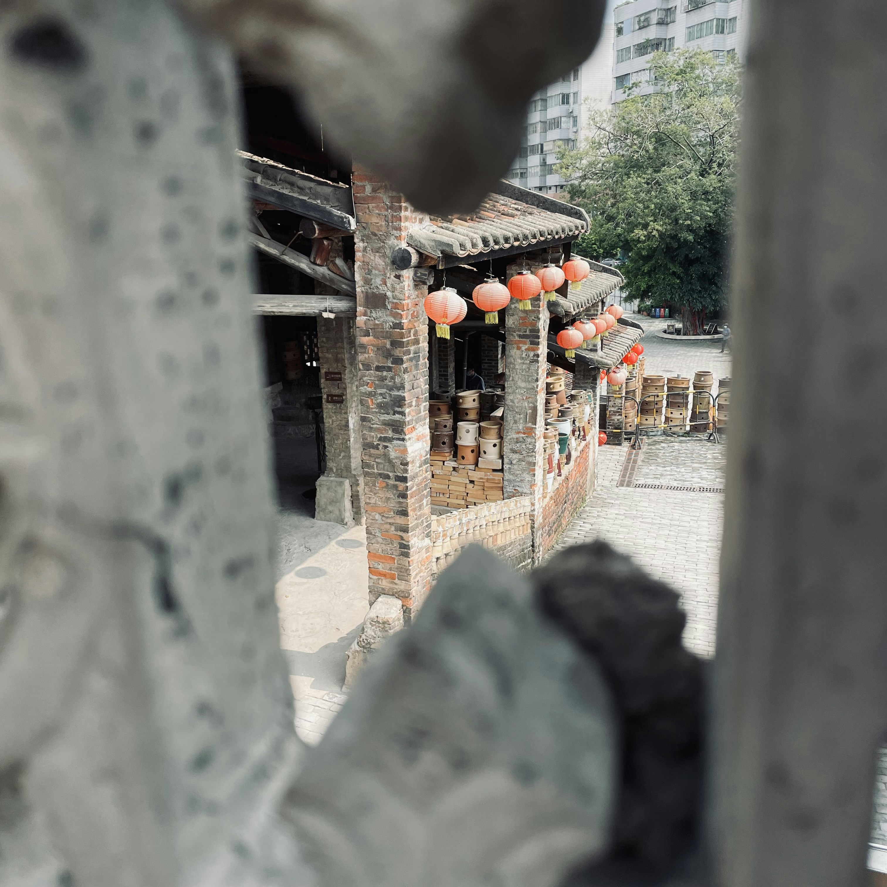 Lanterns in Brickwork: A Framed Streetshop Along the Quiet Lane