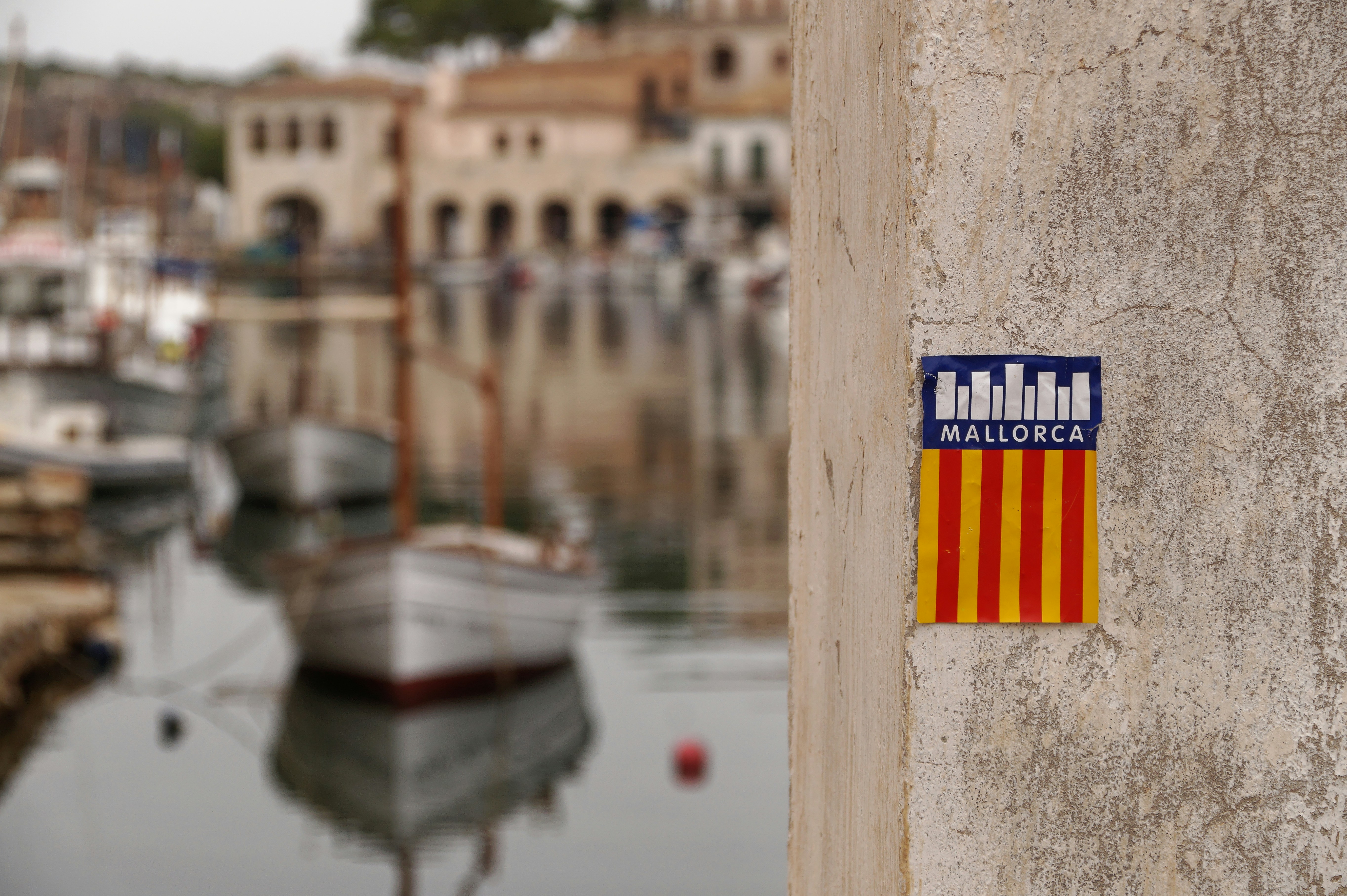 A sticker on the side of a wall near a harbor photo – Free Boat Image ...