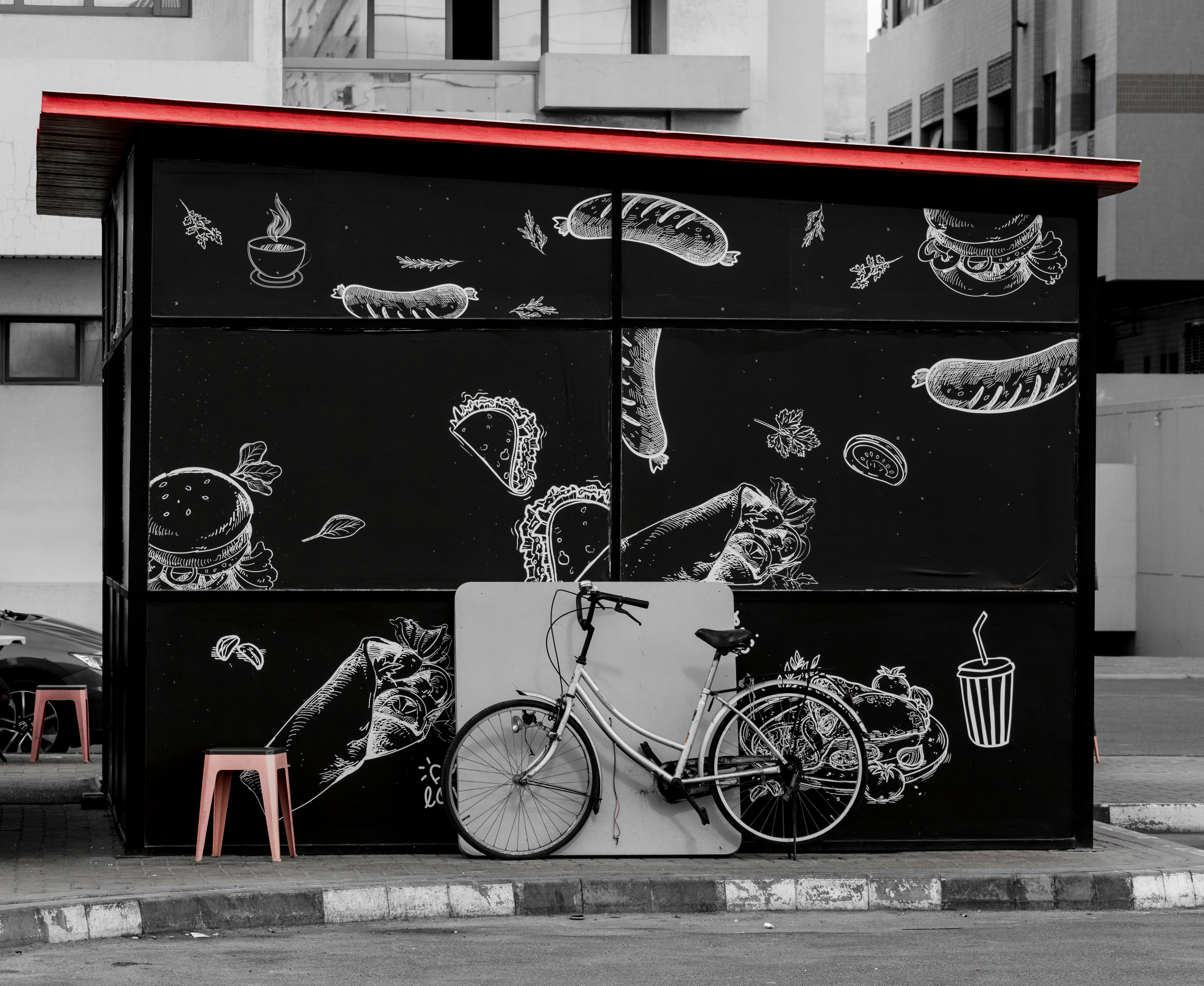 a black and white photo of a building with a bicycle painted on it