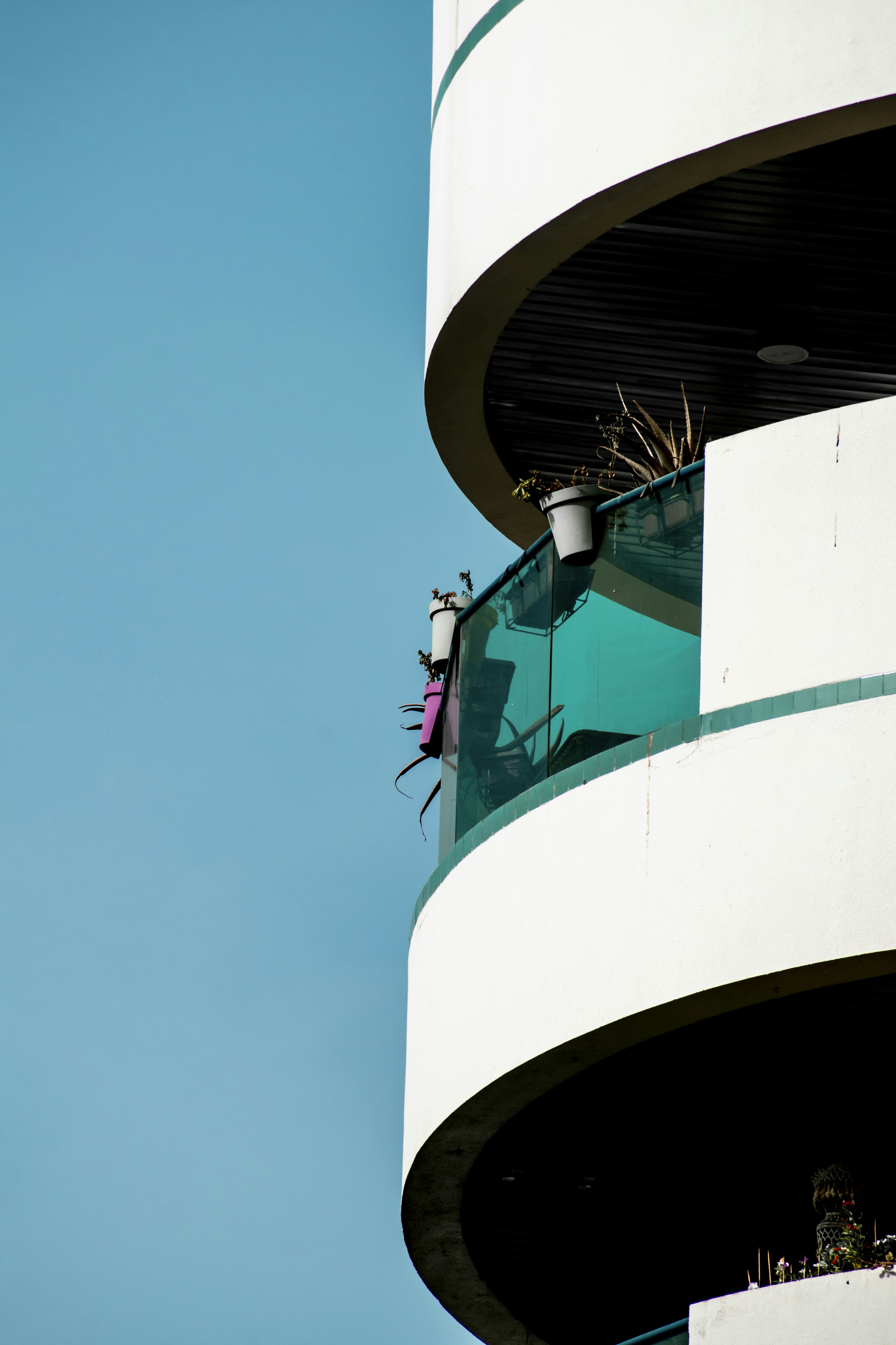 Balconies in Blue: Vertical Architecture with a Pop of Green Glass