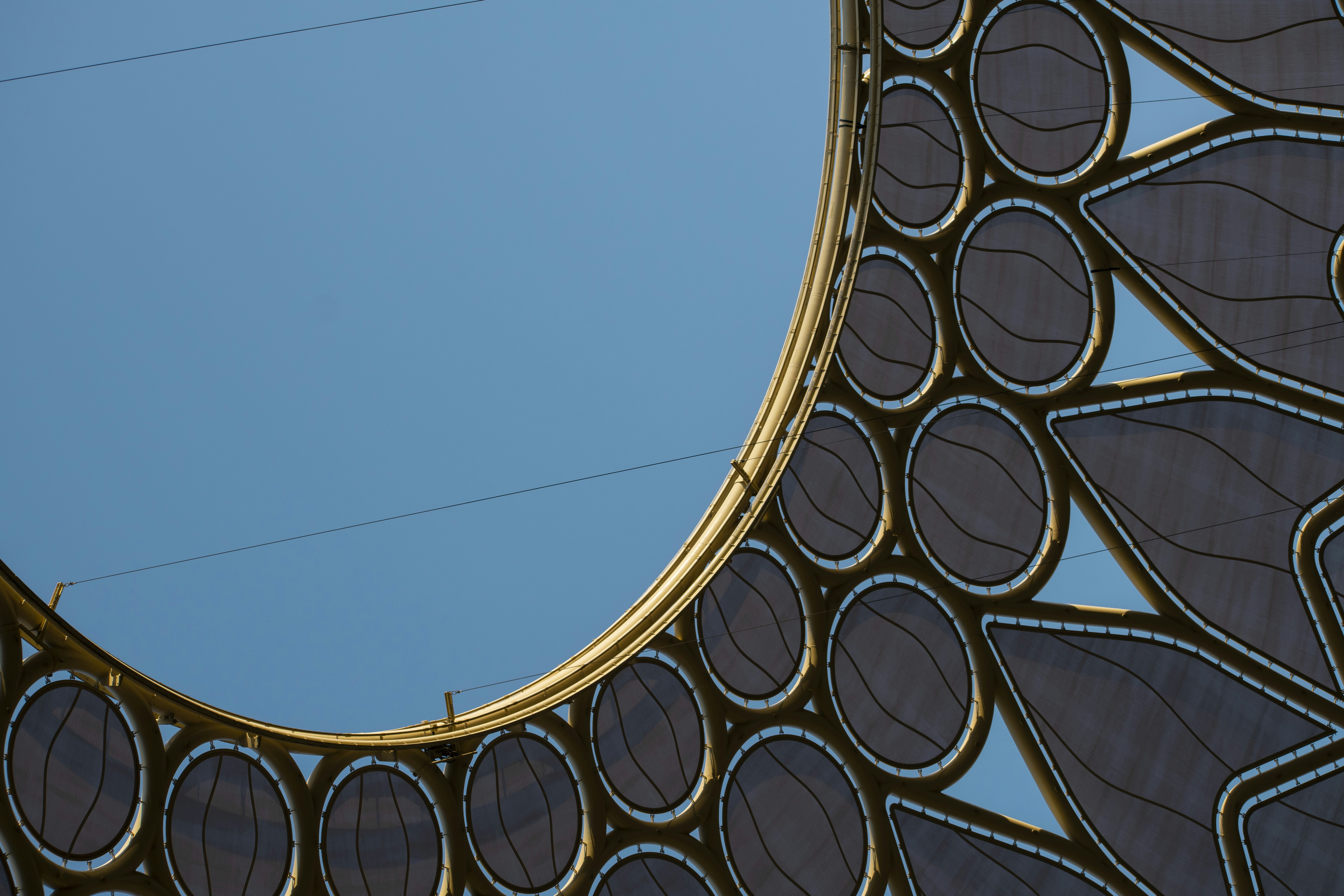 Circular Mosaic: a golden arc embracing a clear blue sky