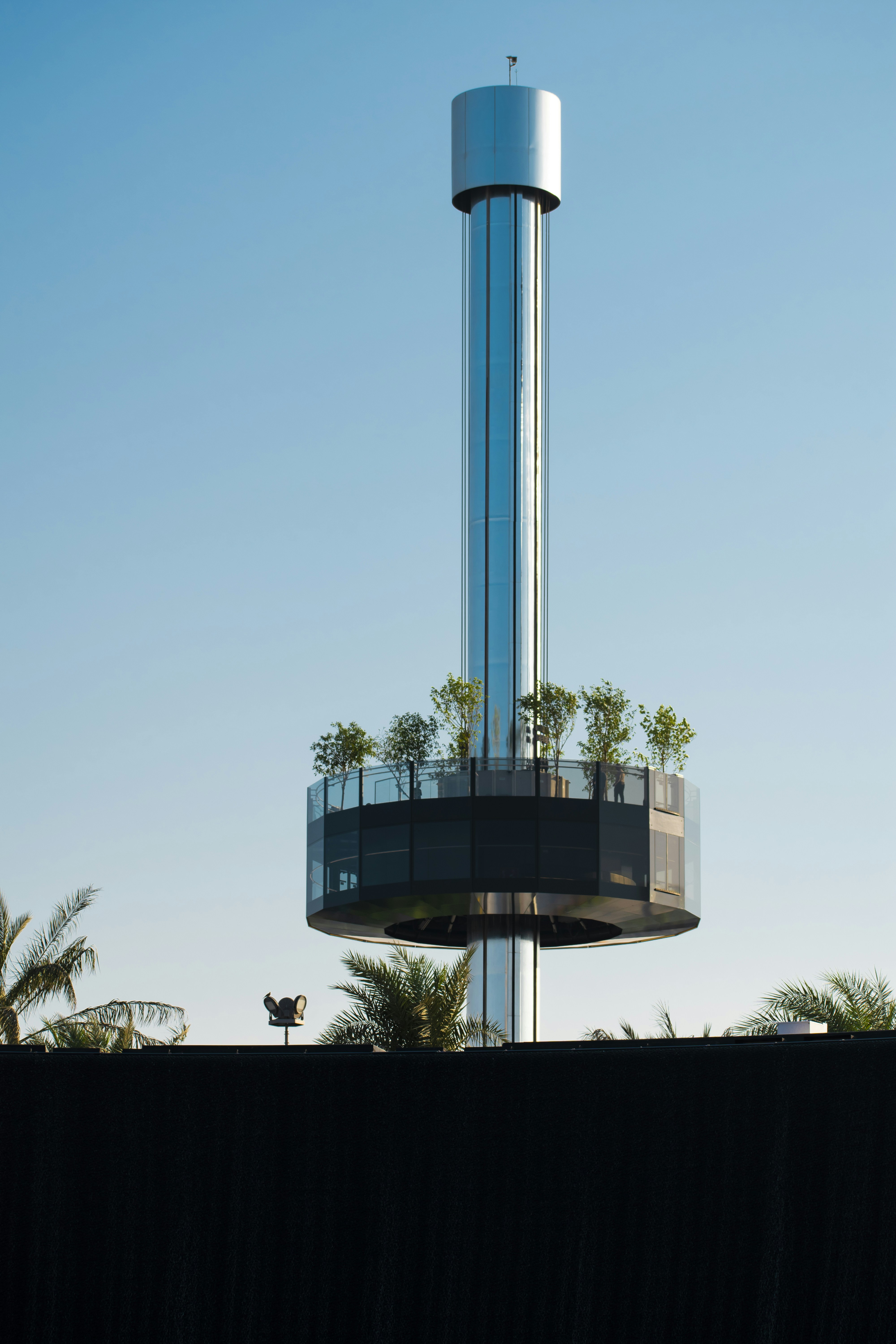 a tall tower with a planter on top of it