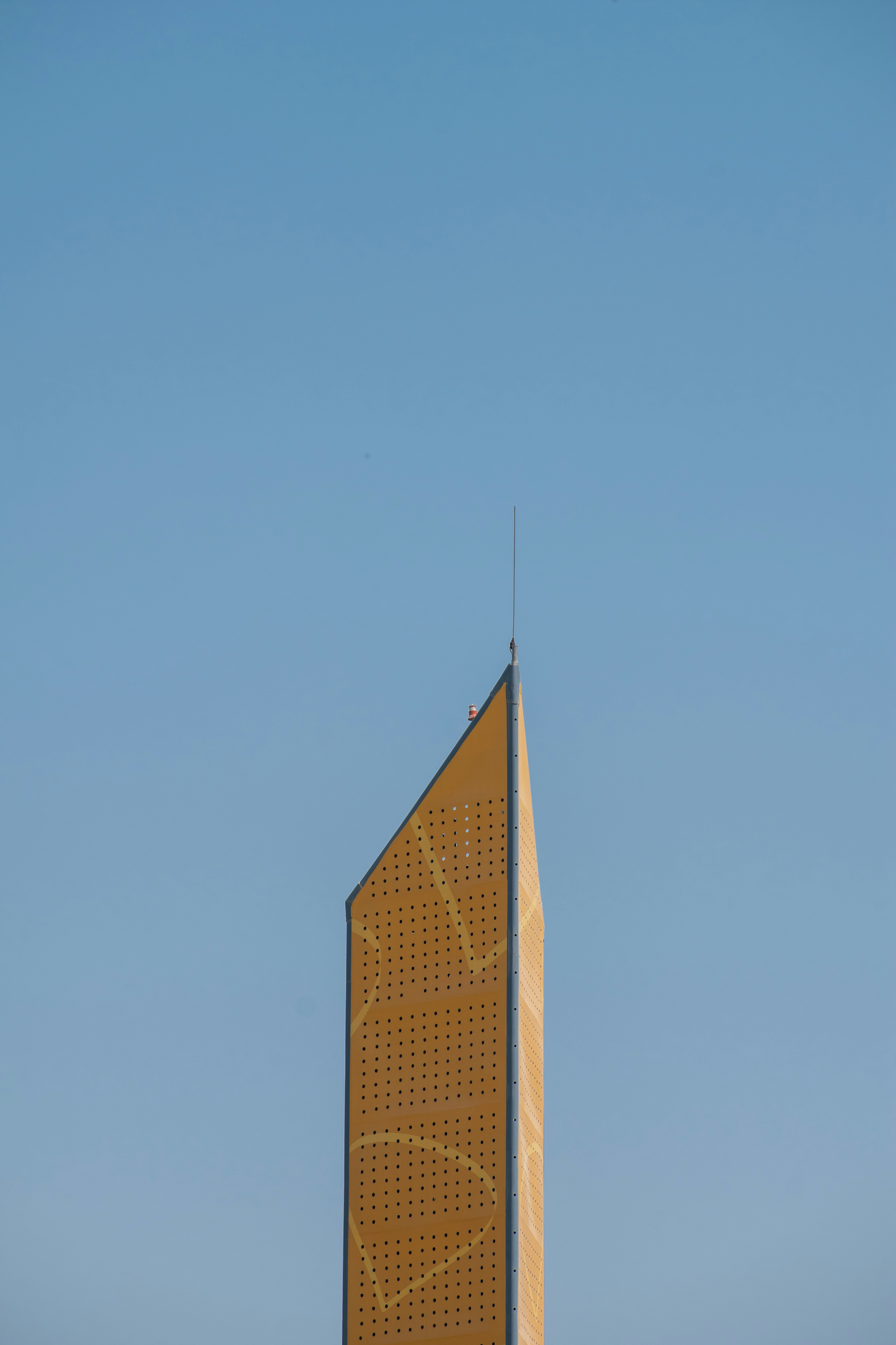a tall building with a sky in the background