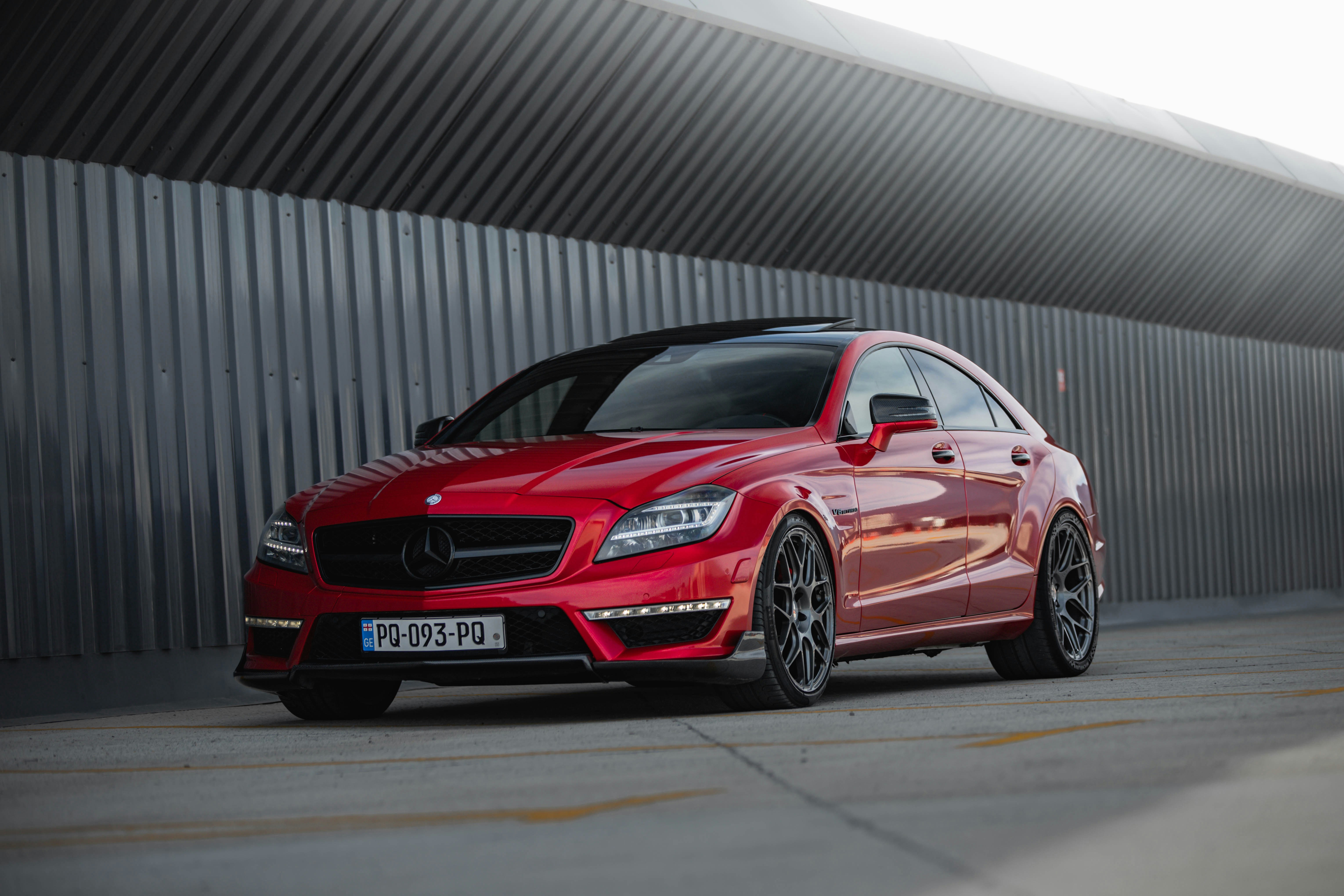 A red mercedes cla parked in front of a building photo – Free ...