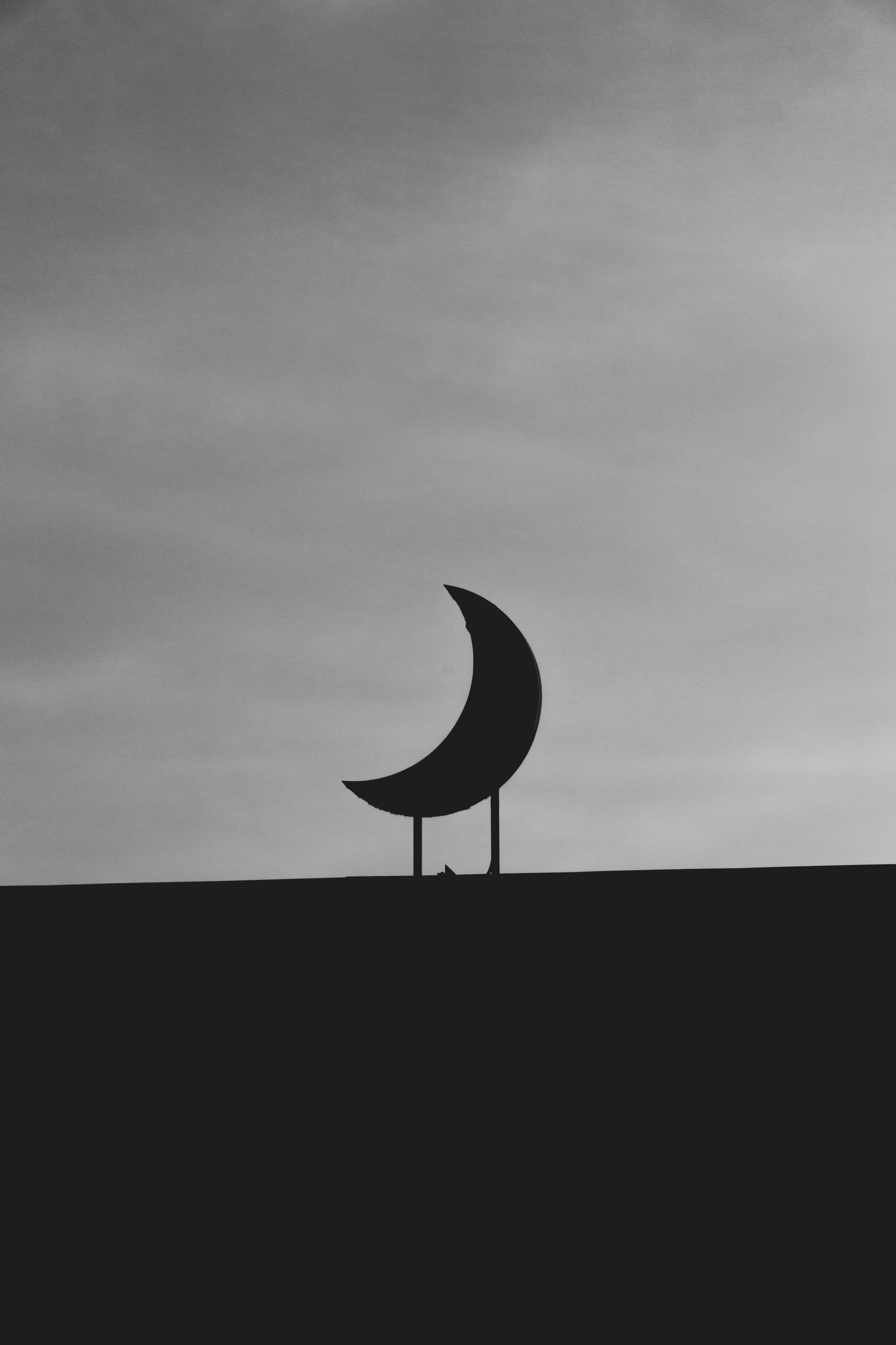 Moon Crescent Signage on a Quiet Roof Edge