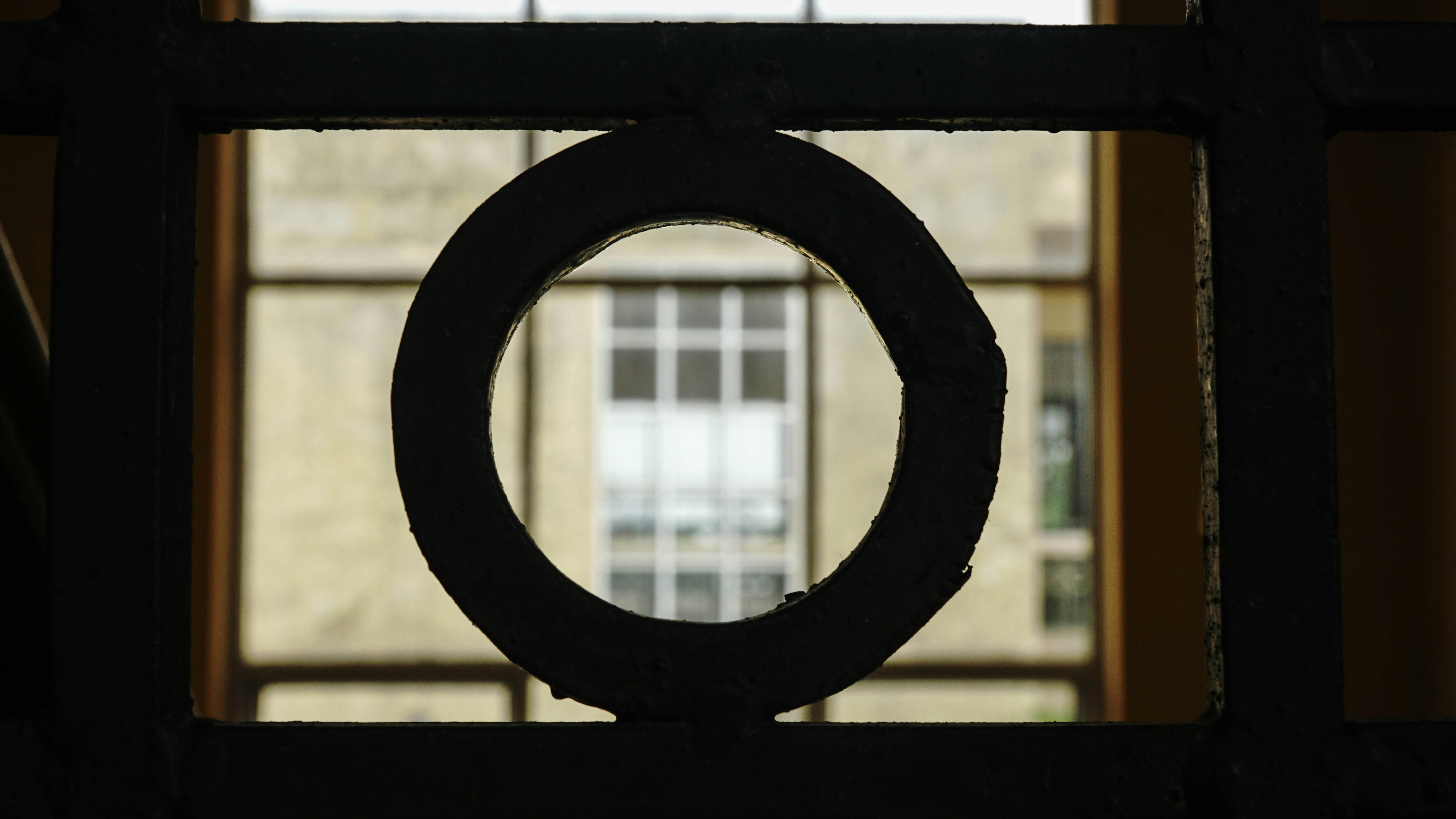 A close up of a circular object in front of a window photo – Free Wheel ...