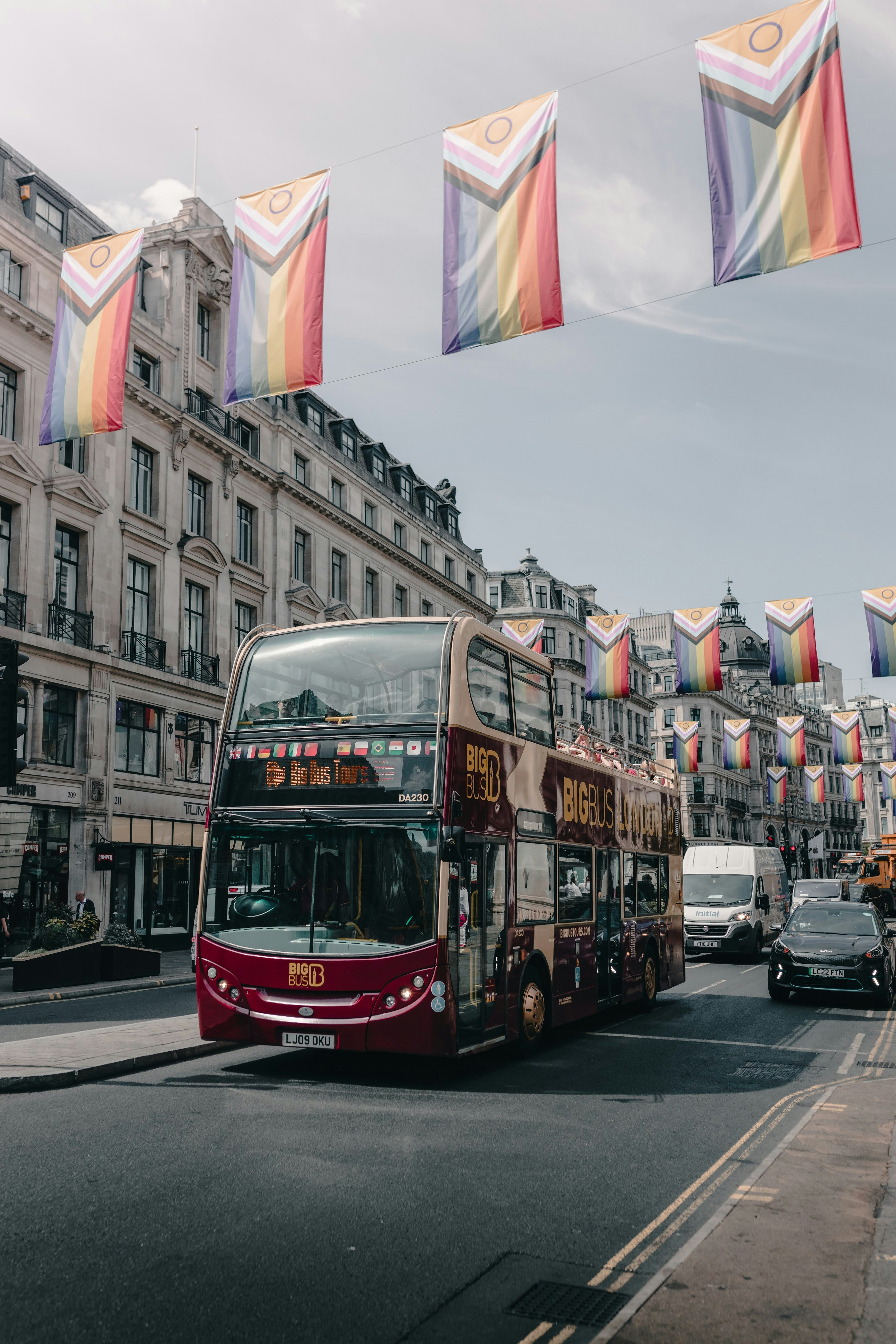 Red Double-Decker Through a Rainbow-Flag Boulevard in London