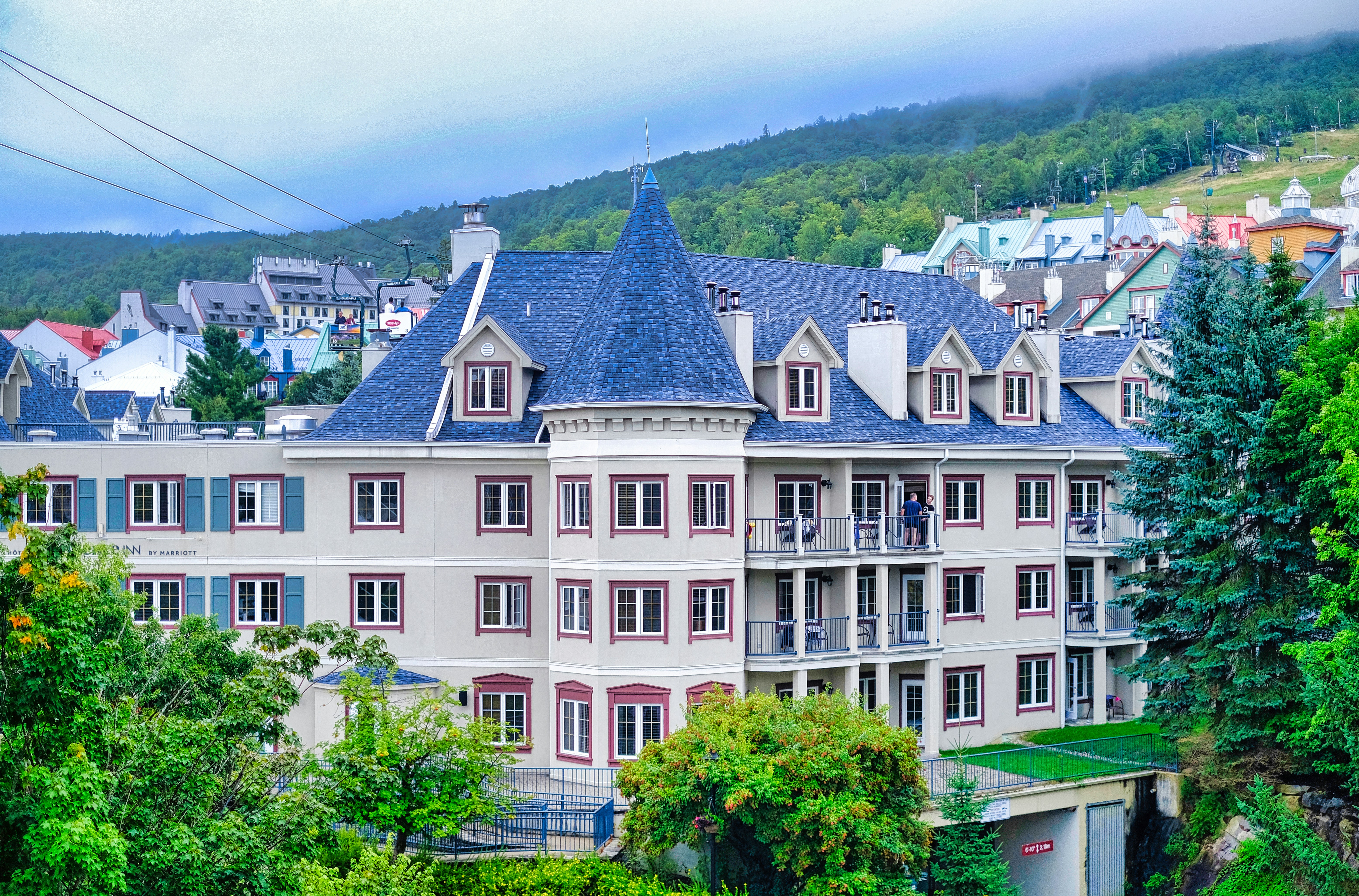 Blue-Topped Turrets Over a Verdant Alpine Village in Mist