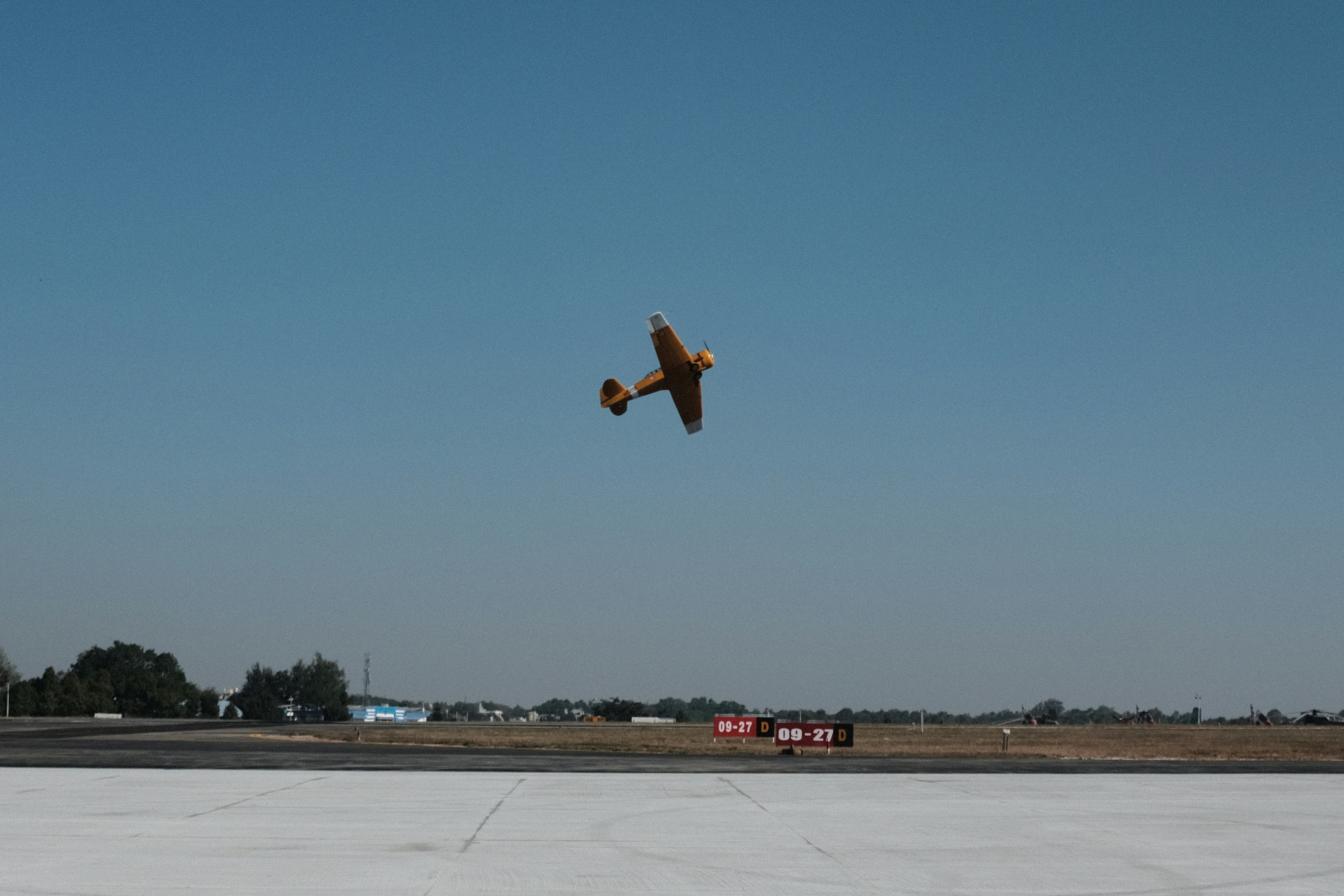 Orange Streak Over the Quiet Runway: A Minimal Sky Moment