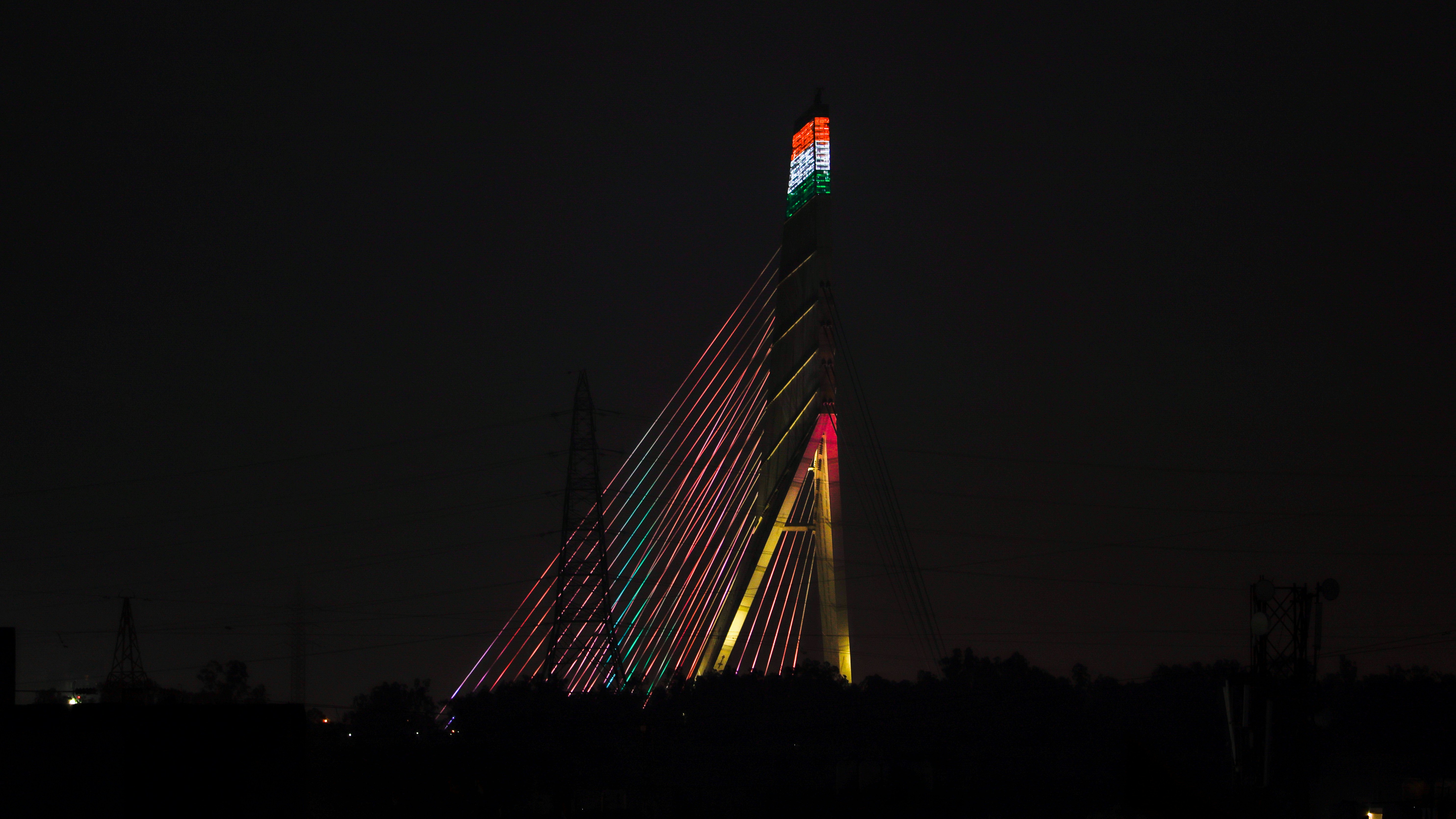 Chromatic Apex: A Rainbow-Lit Cable-Stayed Bridge at Night