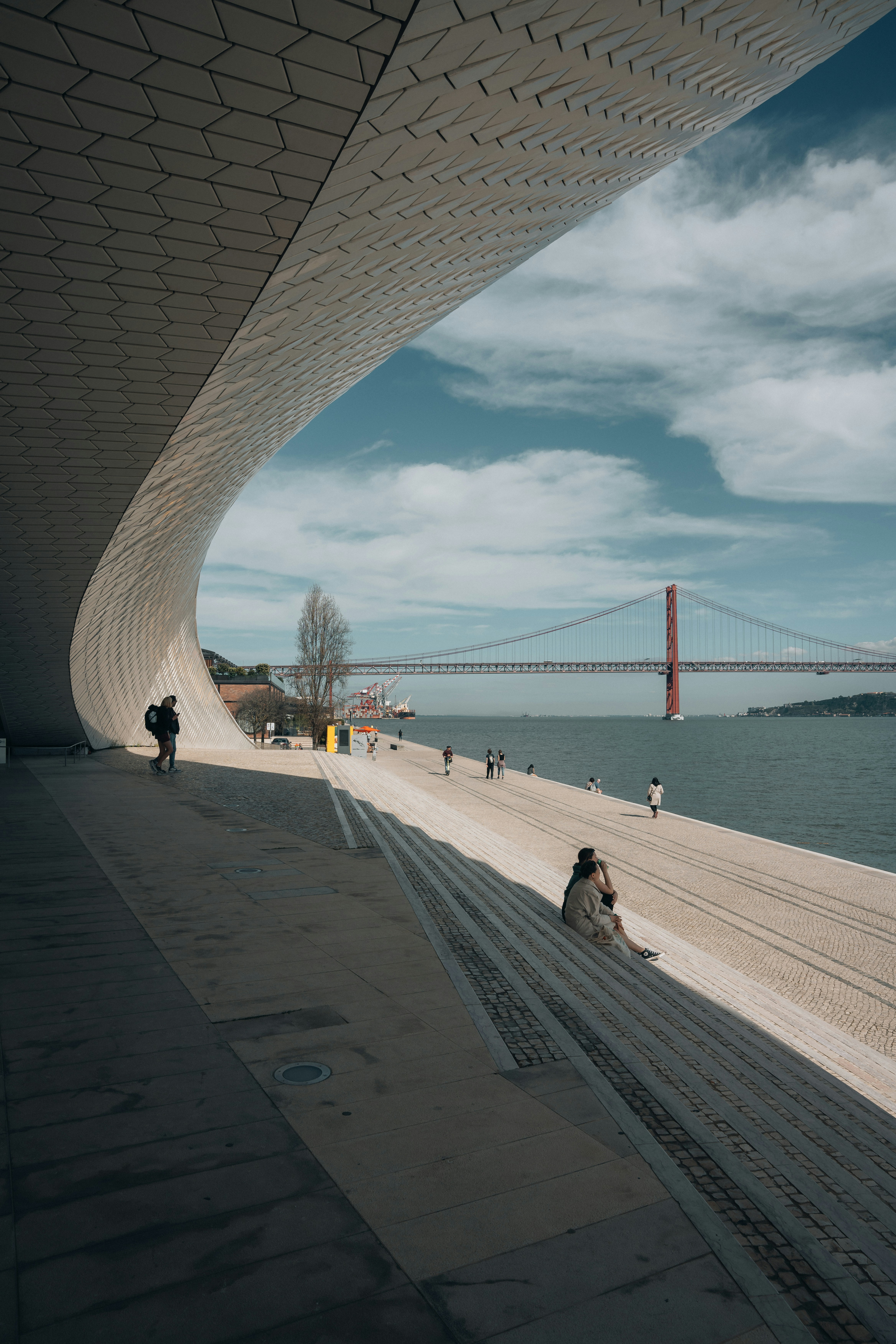Curve of Light Along the Tagus: Promenade Beneath an Arching Waterfront Canopy