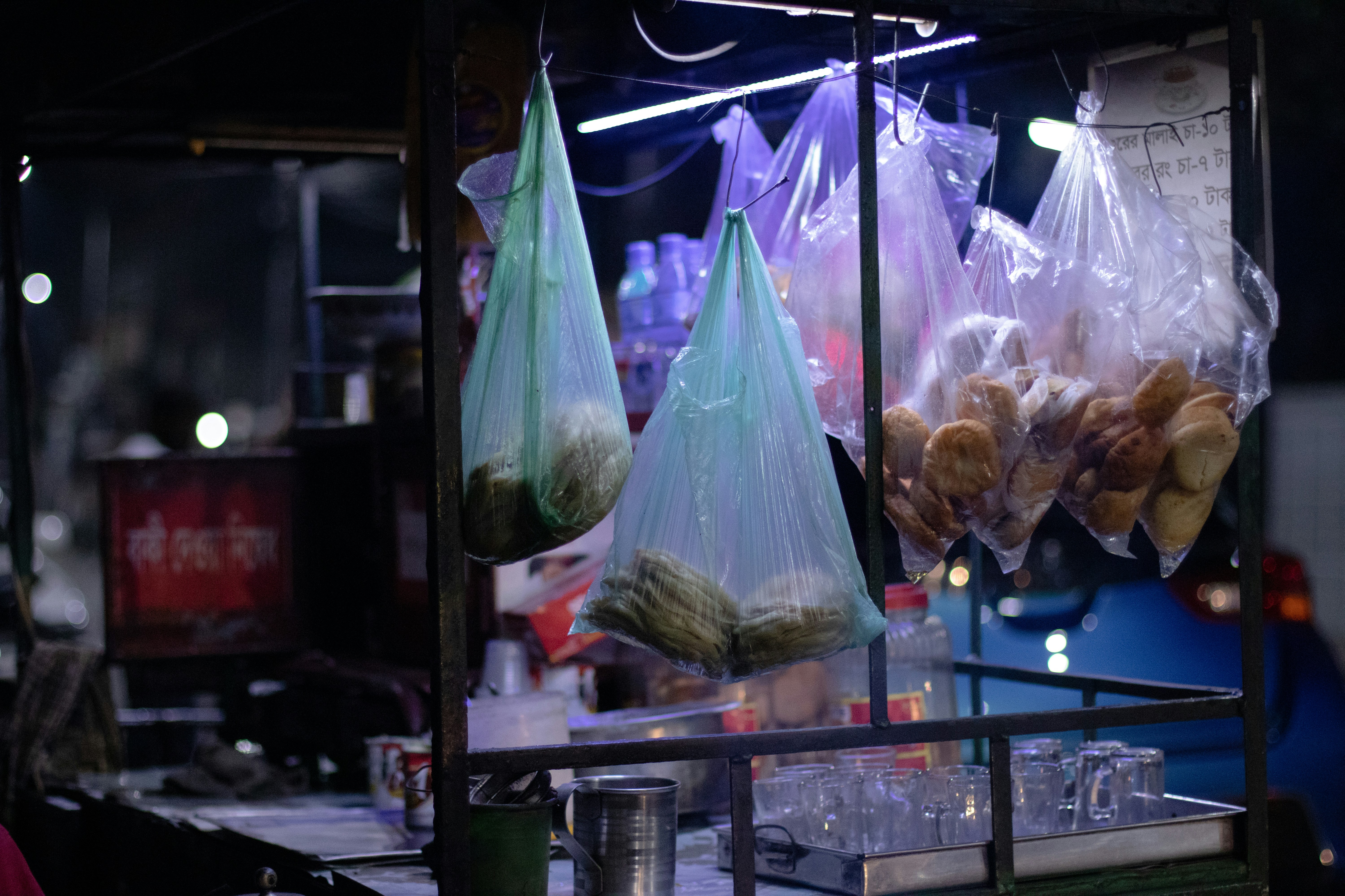 Hanging Freshness: Poultry Bags Amid Night Market Lights