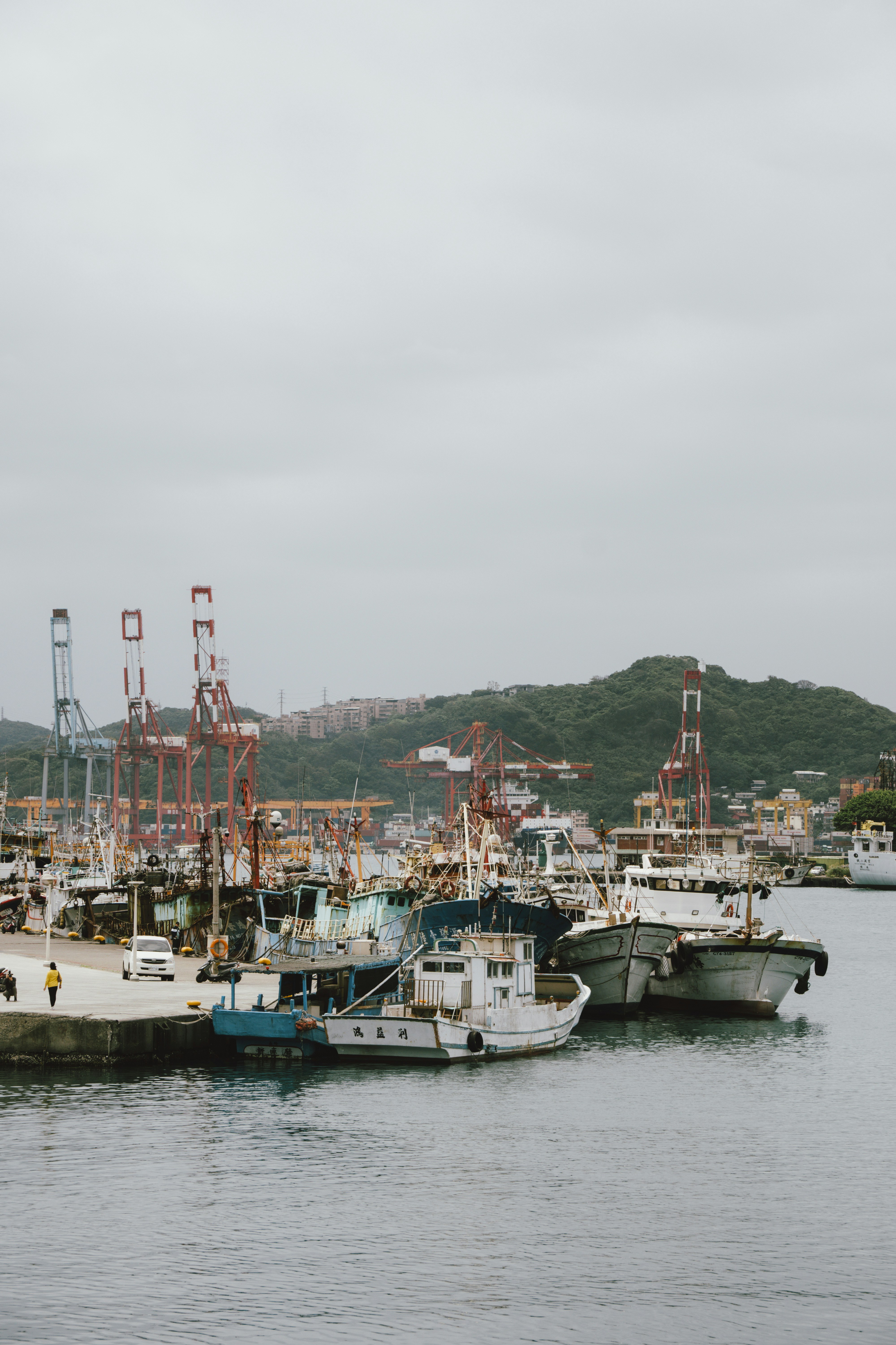 Blue Wake at a Crane-filled Harbor