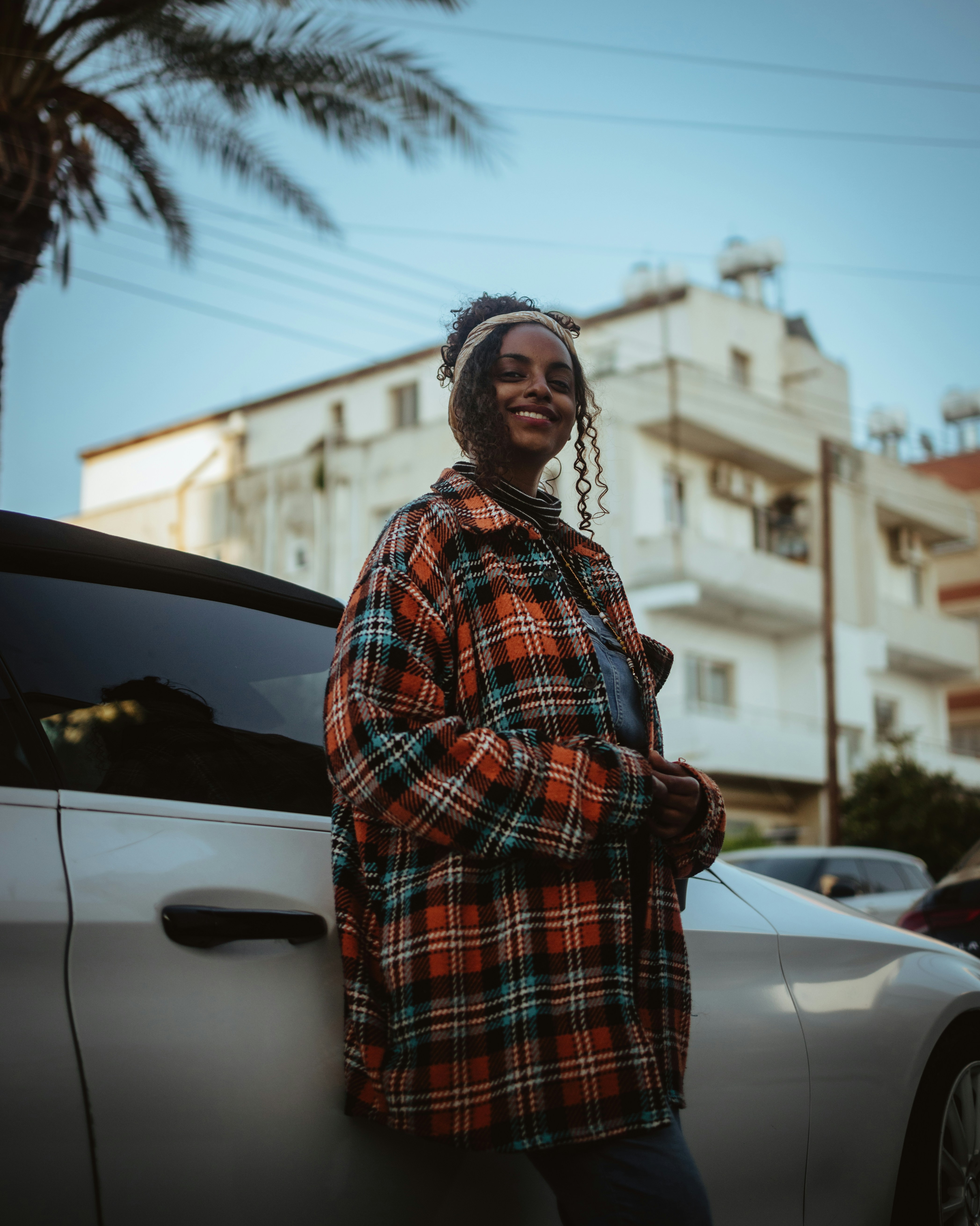 Plaid in the Urban Light: Portrait by a Car Door