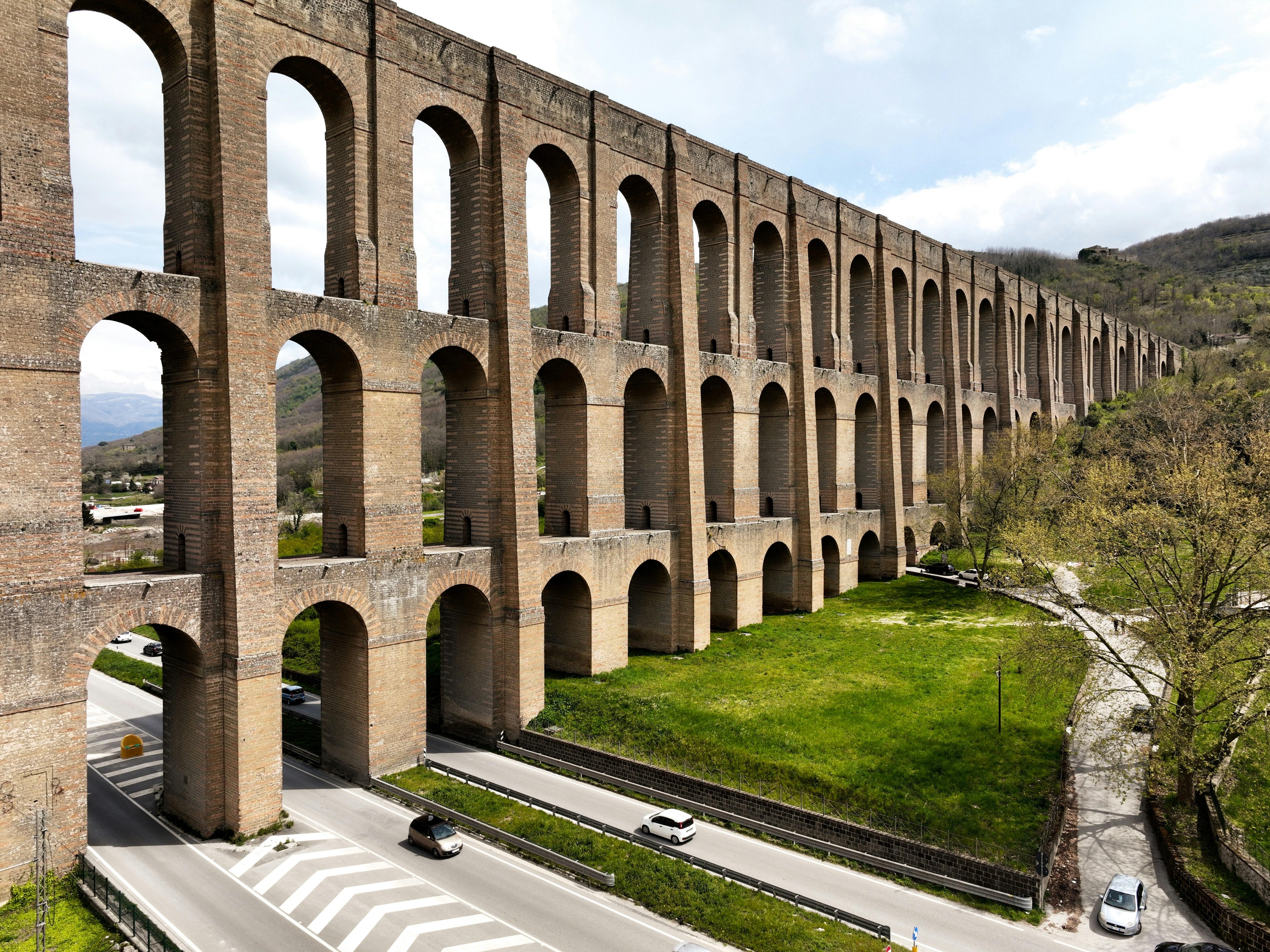 A large brick structure with arches on the side of it photo – Free ...