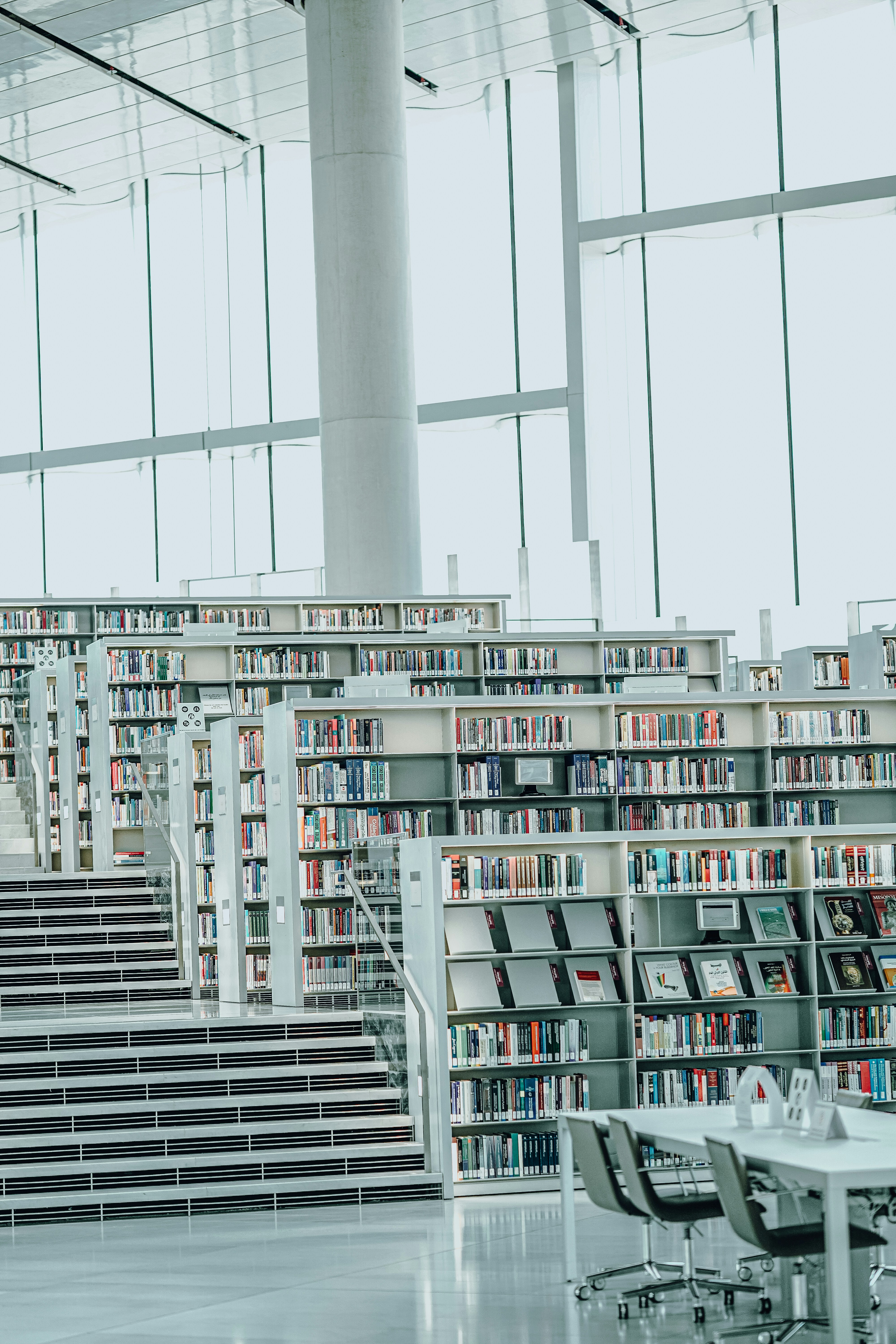A library filled with lots of books and stairs photo – Free Doha Image ...