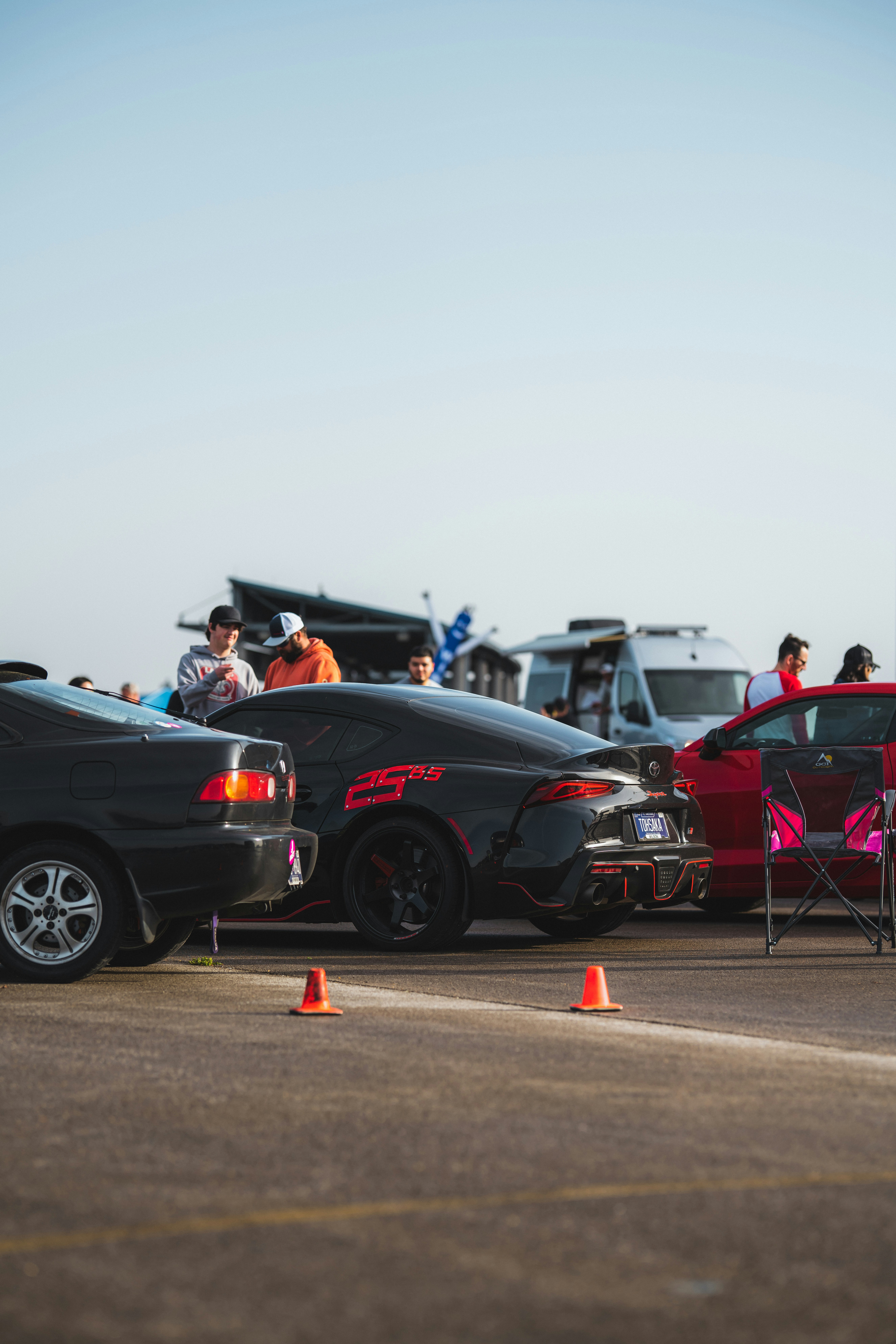 Midfield Motors: A Row of Parked Cars and Onlookers at a Show