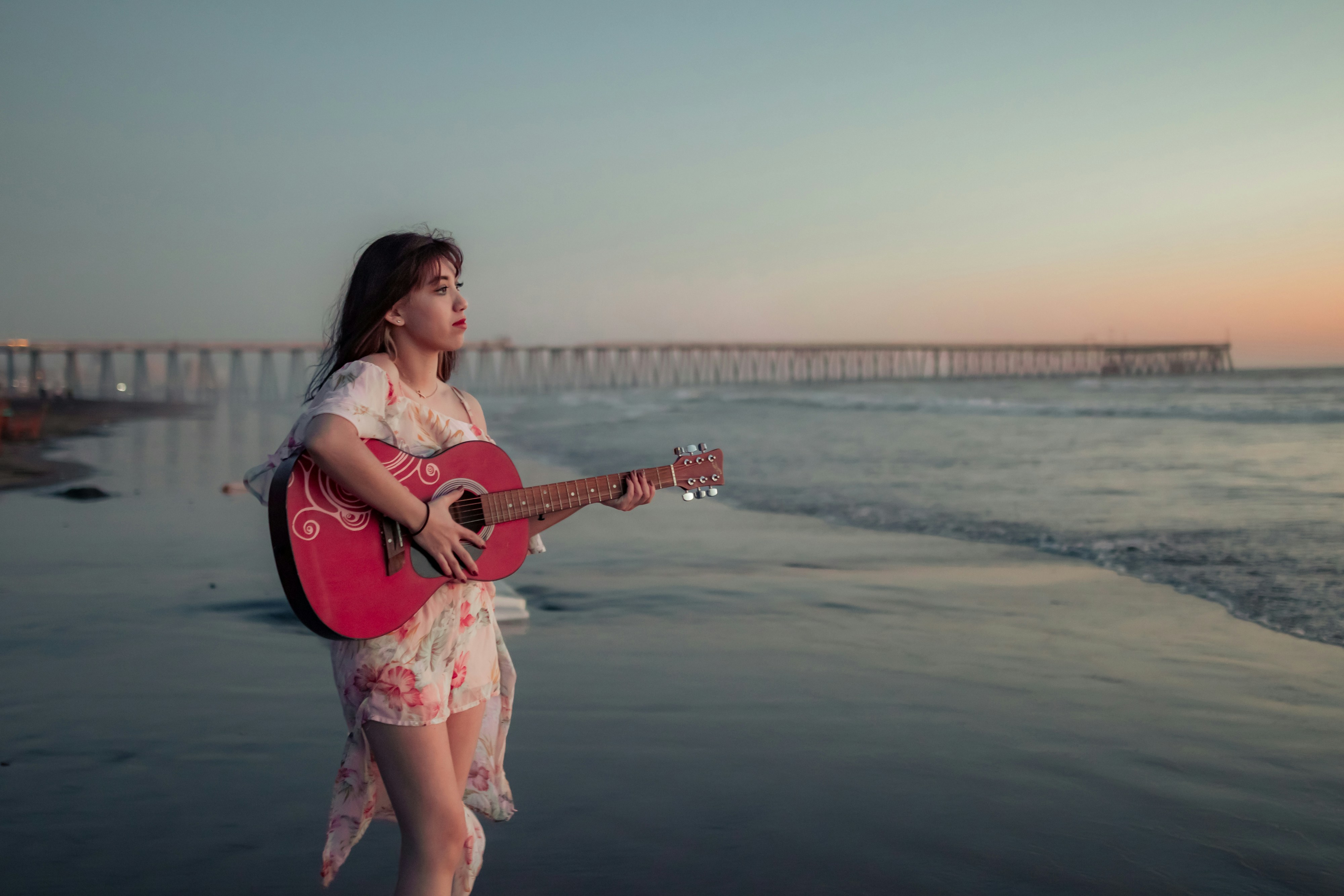 Dusk Strings by the Sea: A Pink Guitar at the Pier