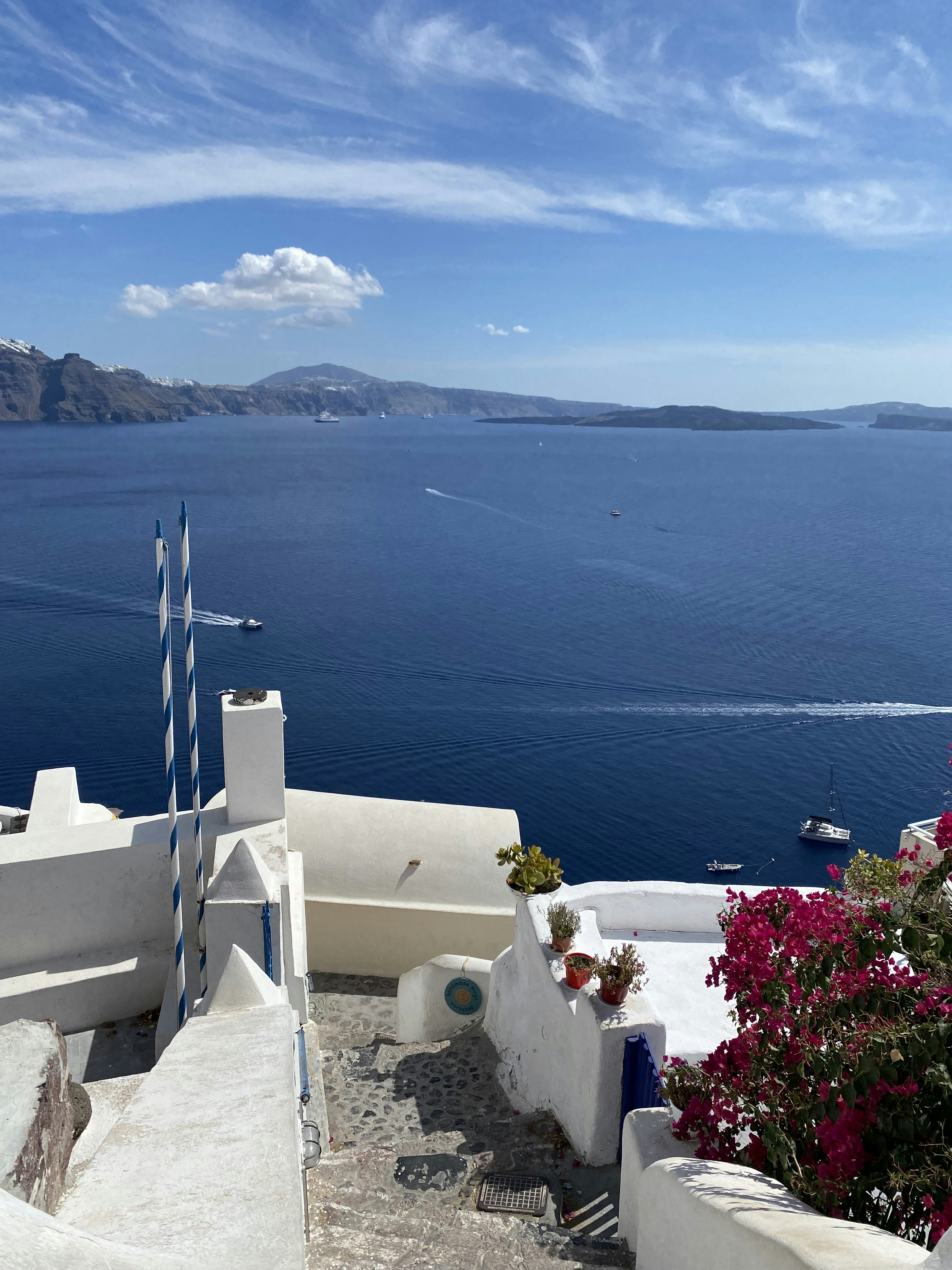Santorini Terrace Over the Aegean: Whitewashed Walls, Blue Sea, and Bougainvillea.