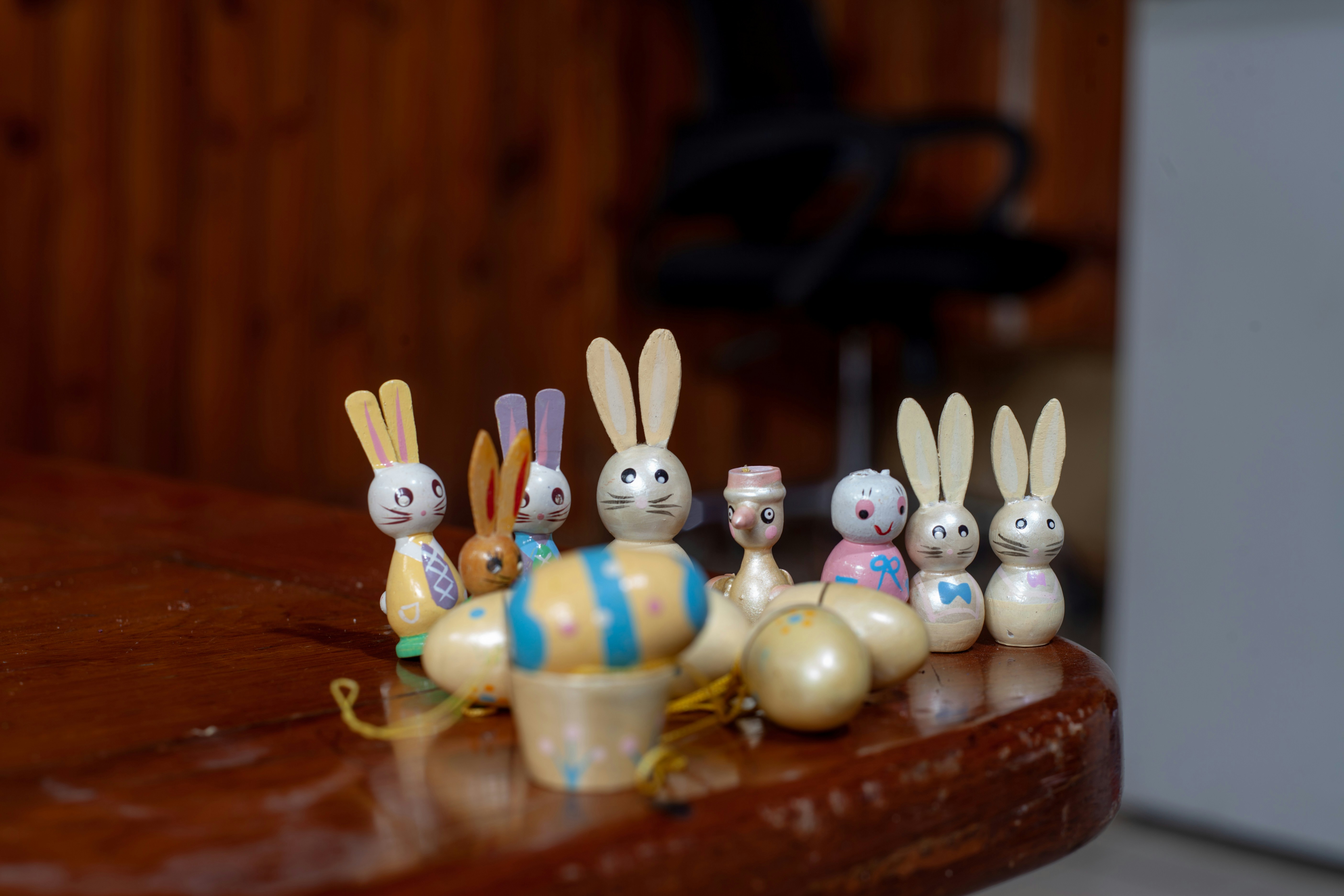 Playful Easter Parade: Wooden Bunnies on a Worn Table