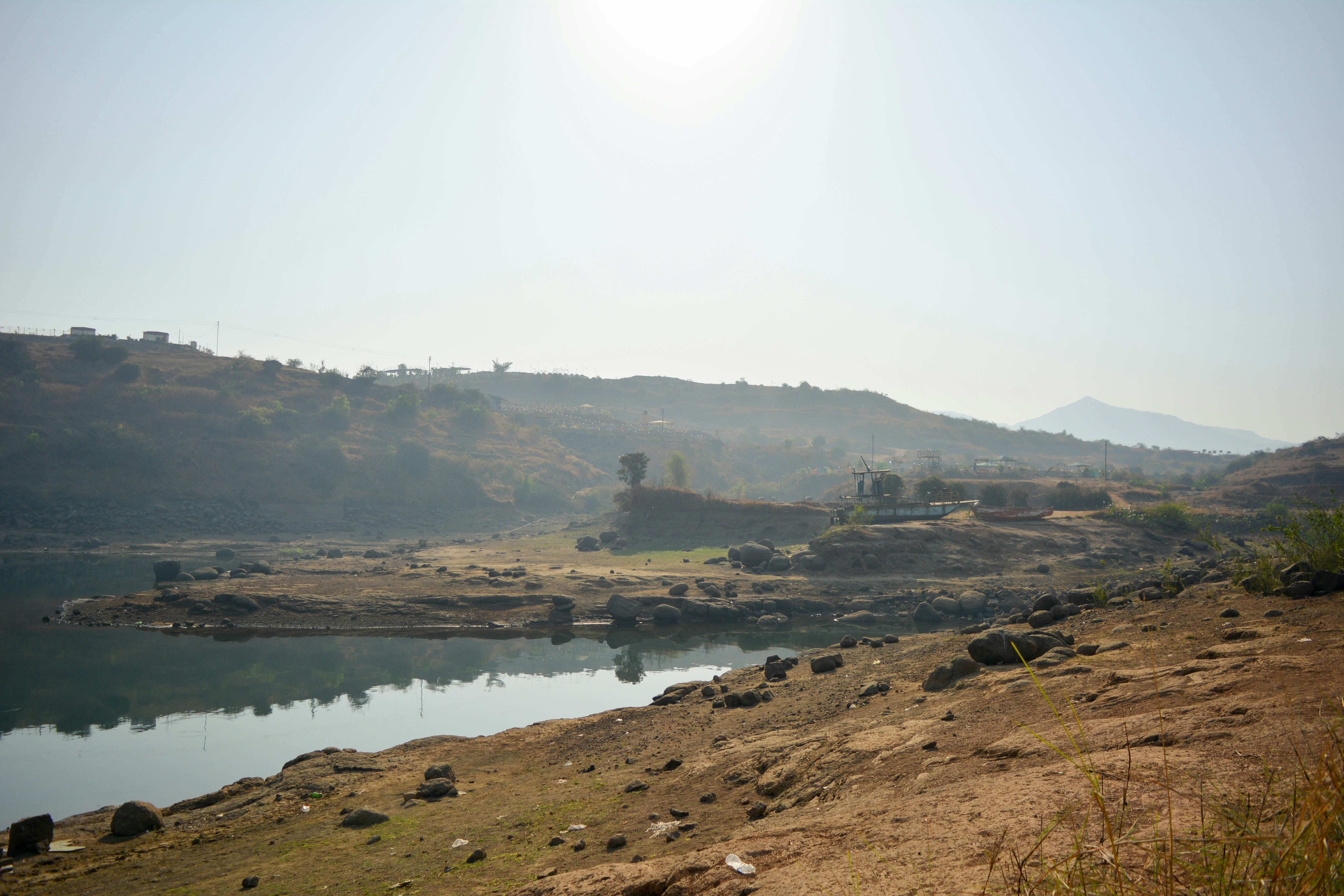 Hazy Riverbend: Rugged Banks and Distant Hills
