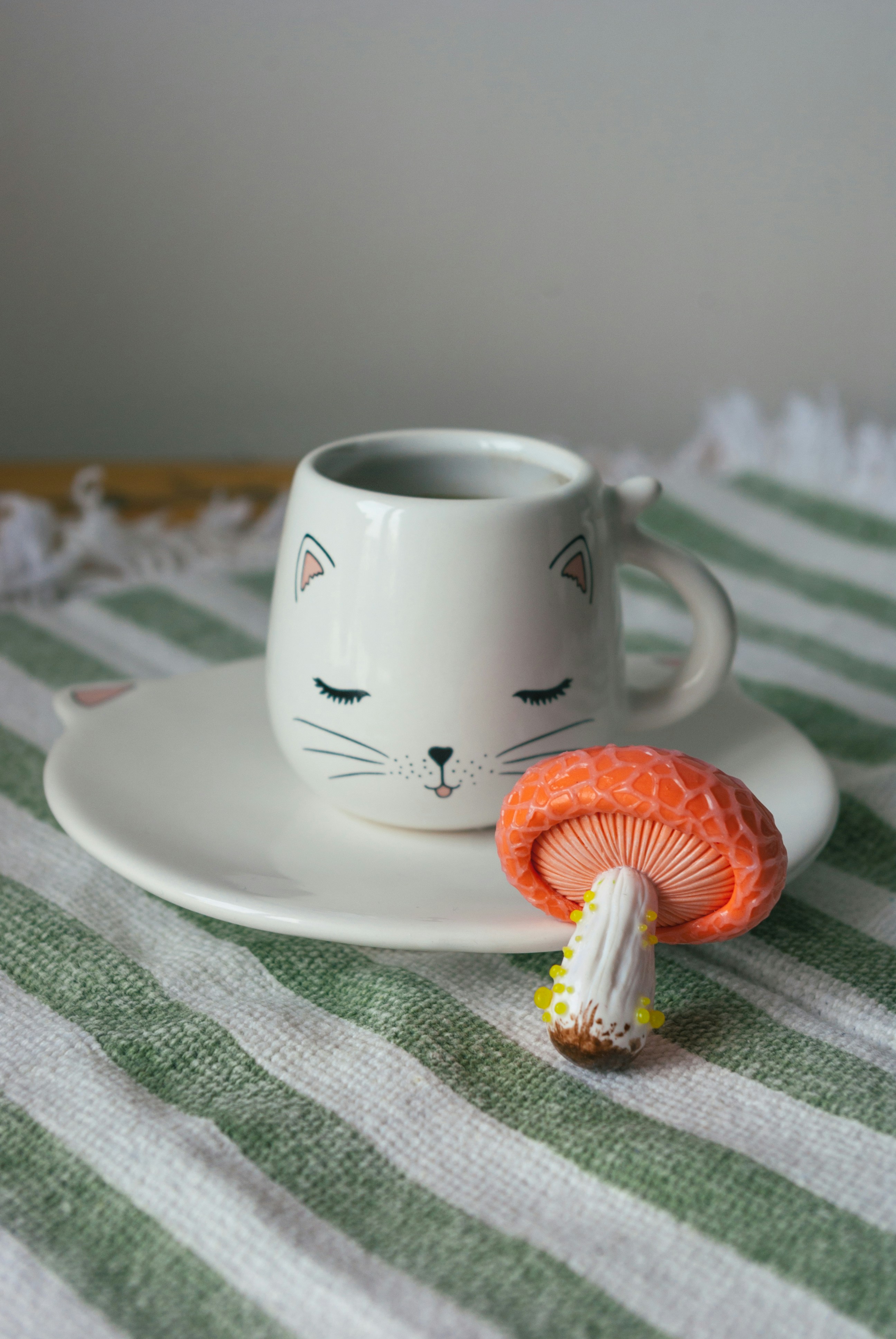 Whiskered Mug and Coral Mushroom: A Quiet Tabletop Moment