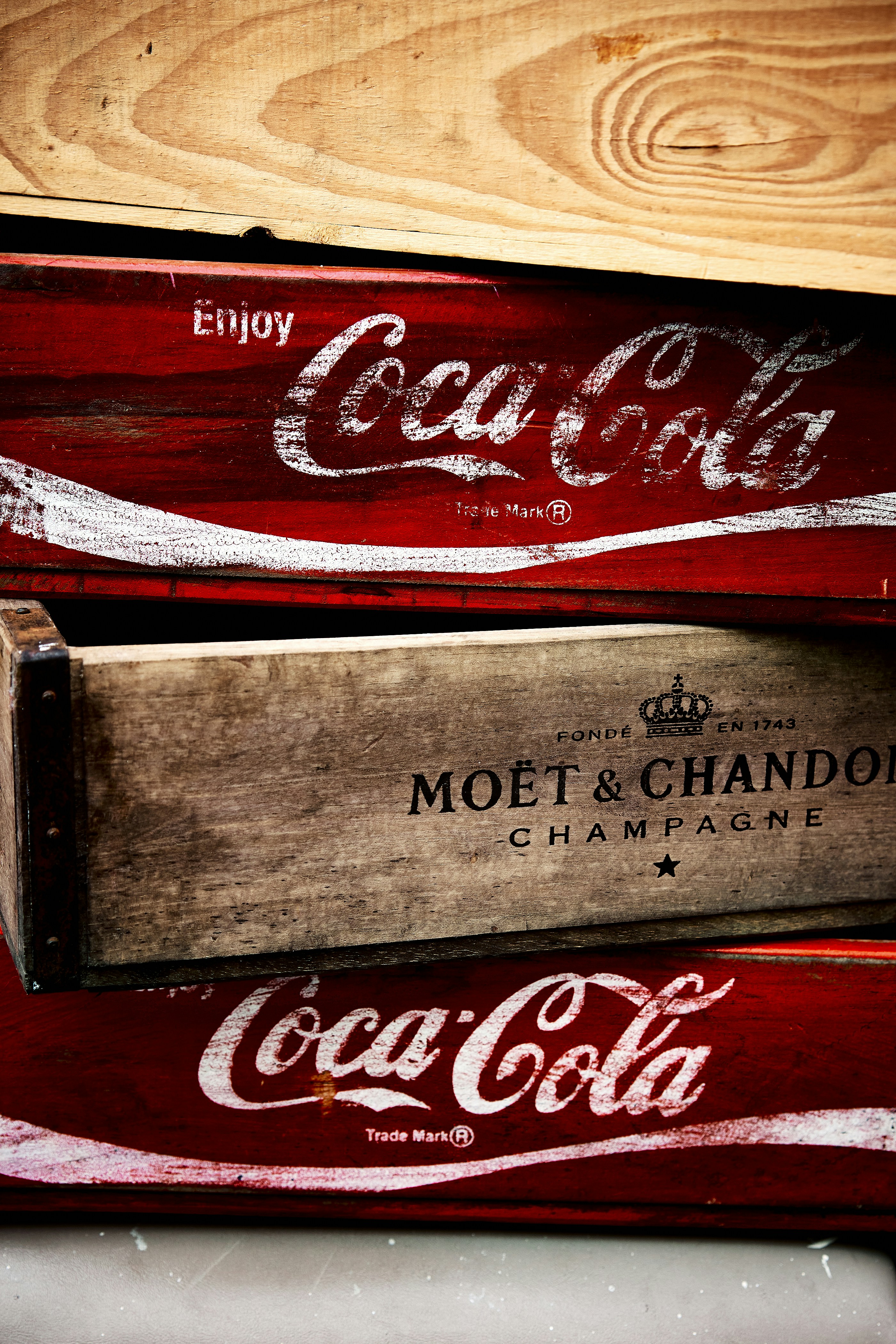 A stack of coca - cola crates sitting on top of a table photo – Free ...