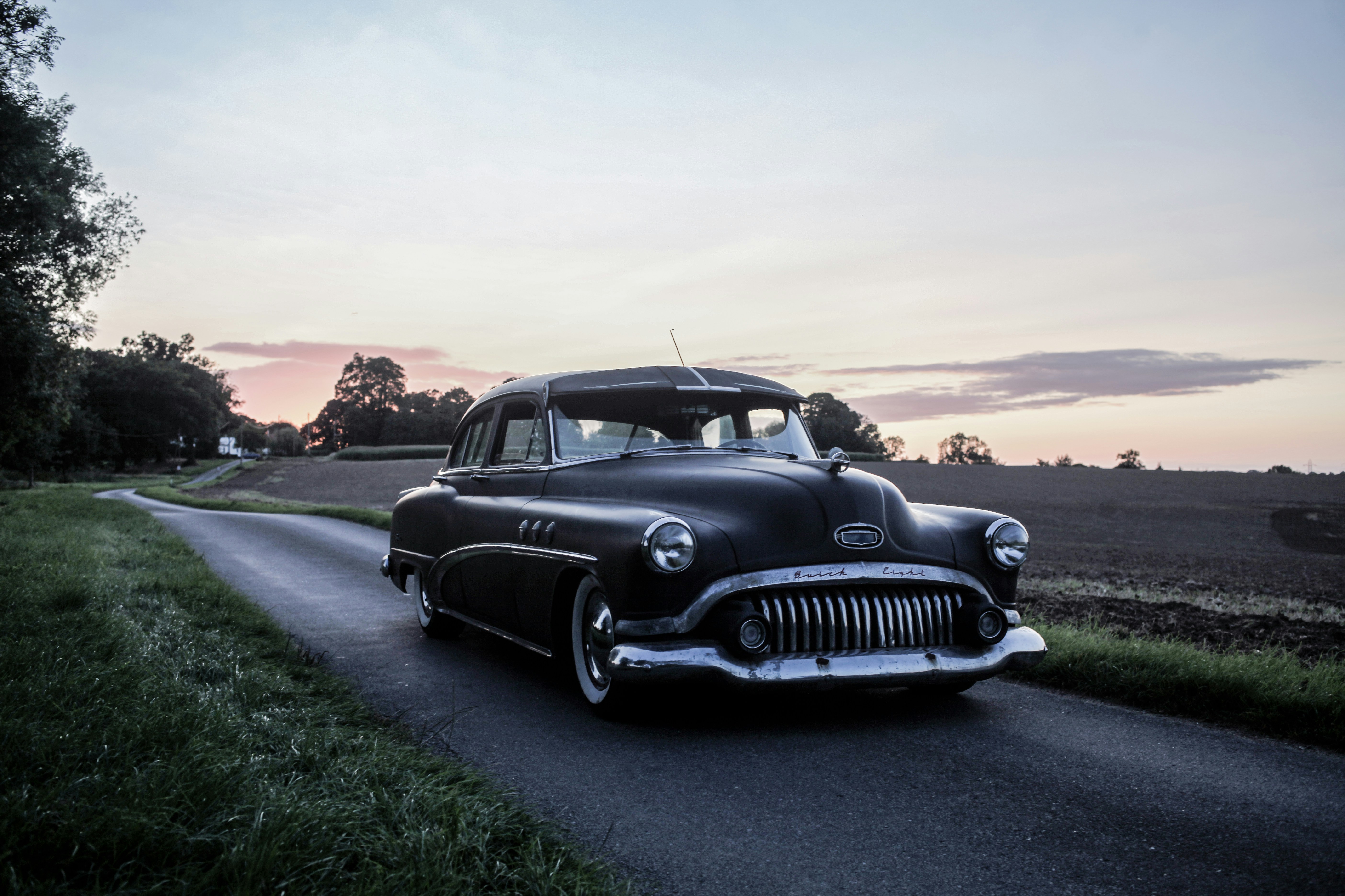 A classic car driving down a country road photo – Free Vintage car ...