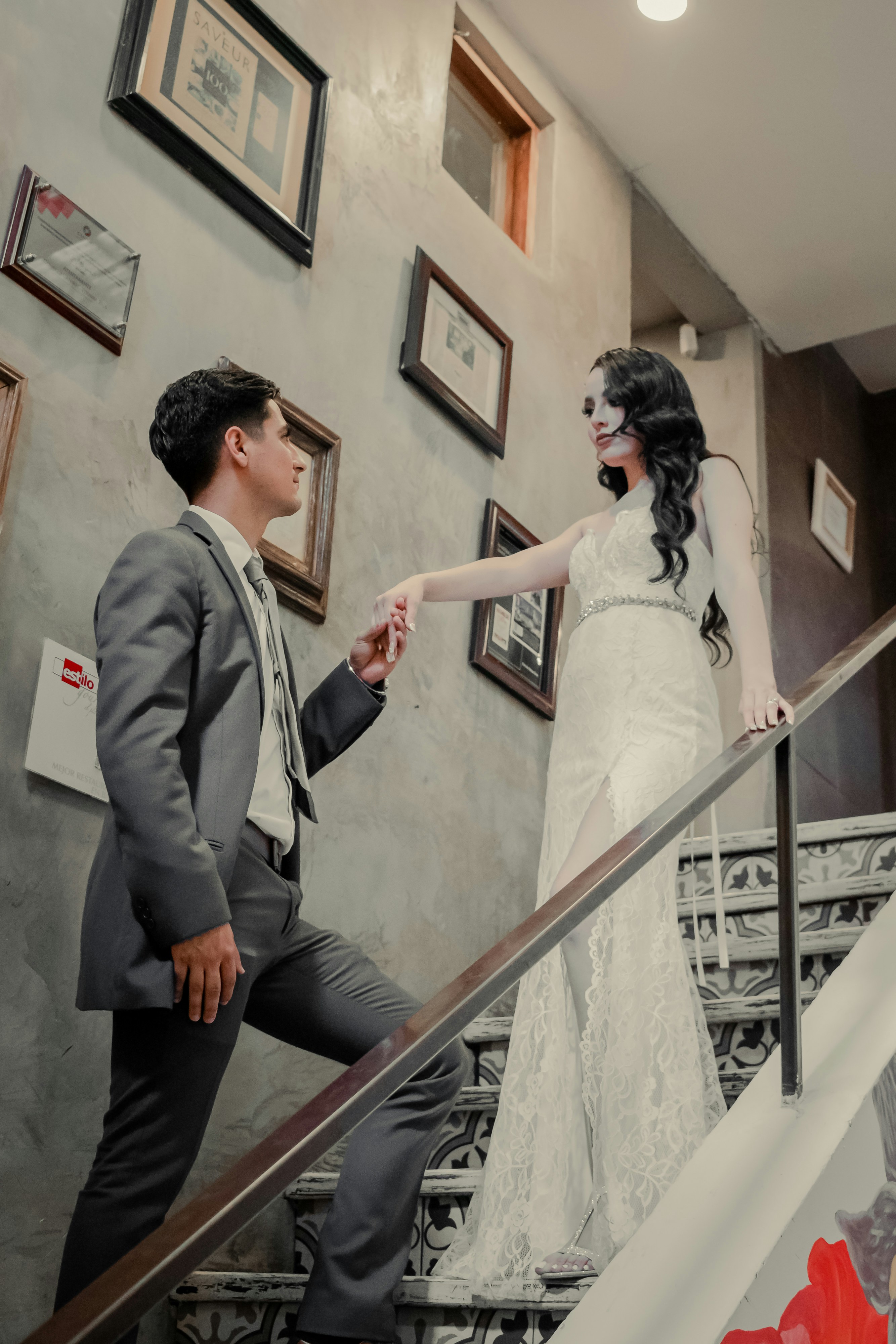 A Quiet Moment on the Staircase: A Bride Reaches to Meet His Hand