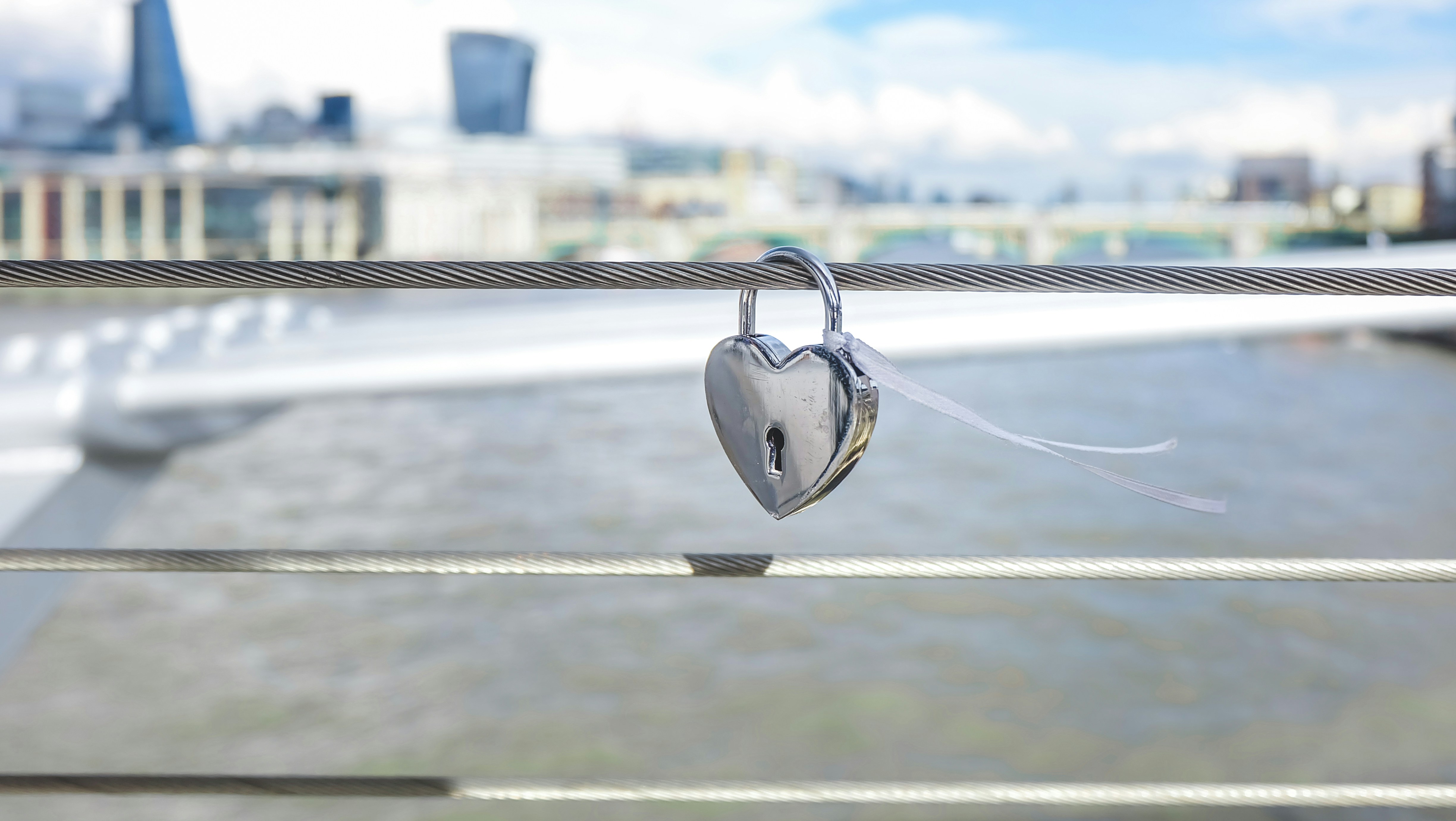 Heart Lock on the Rail: a close-up amid the riverfront skyline